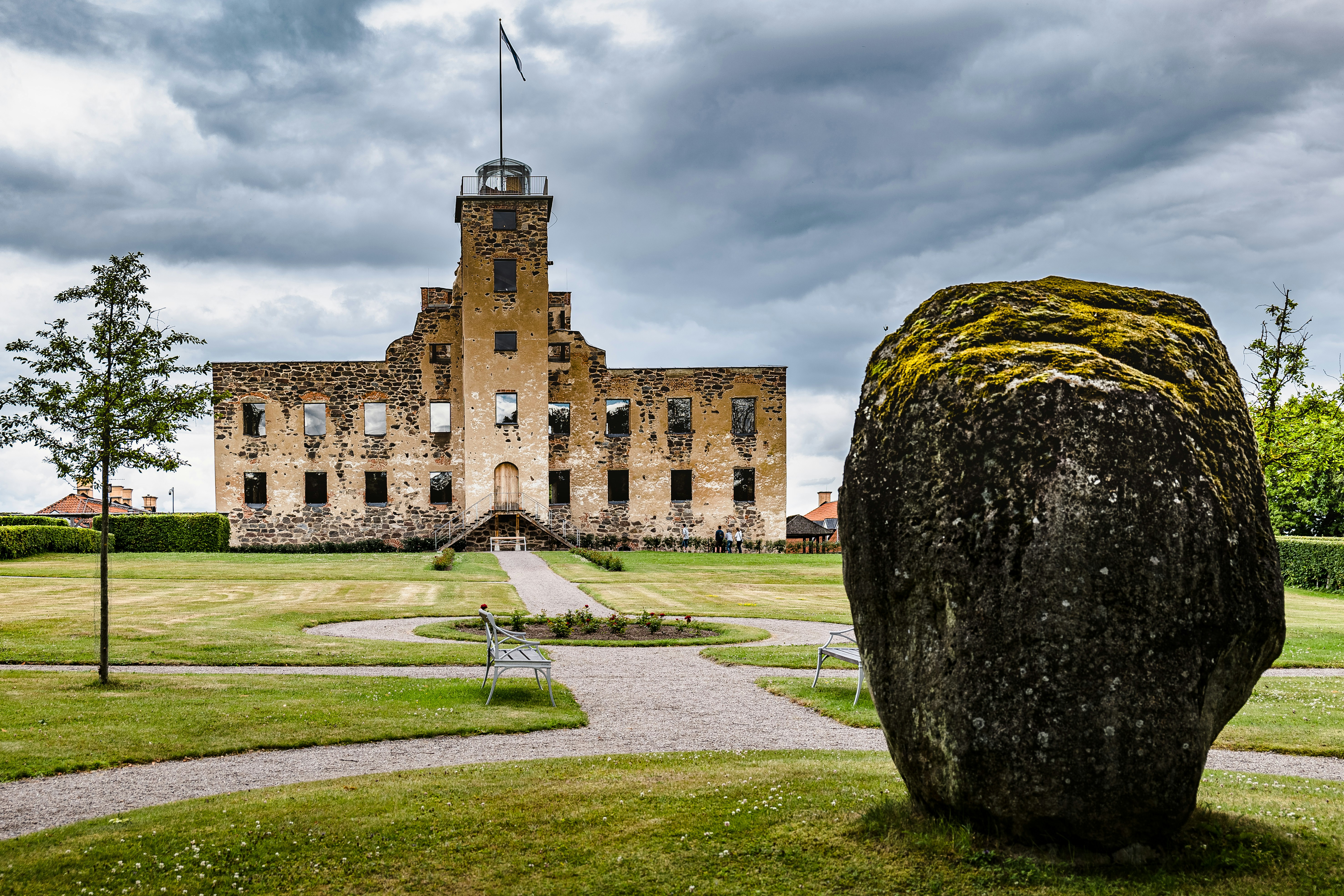 A large stone building with a large rock in front of it photo – Free ...