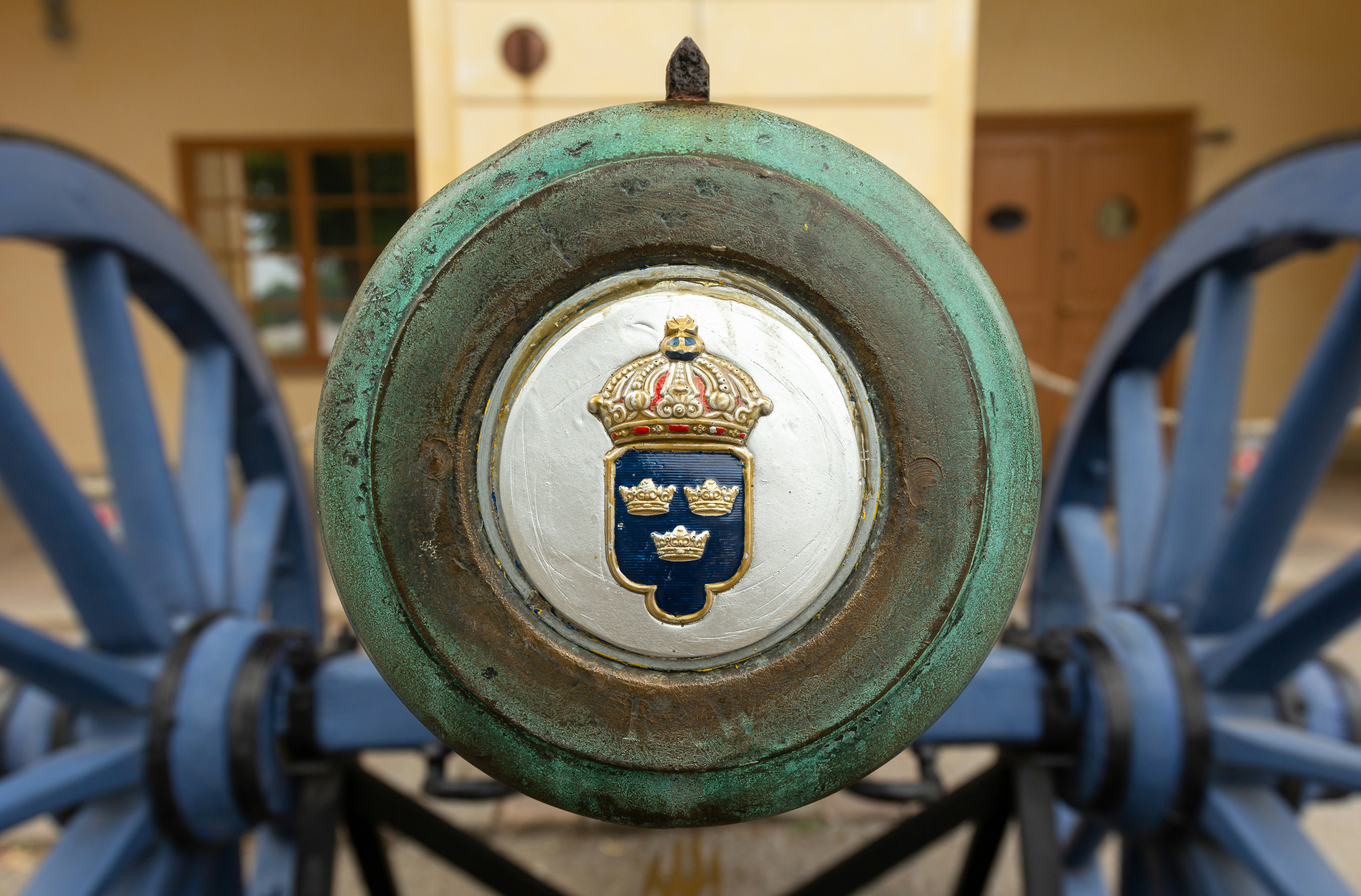 Center Crest: Weathered Royal Emblem on a Blue Carriage Wheel