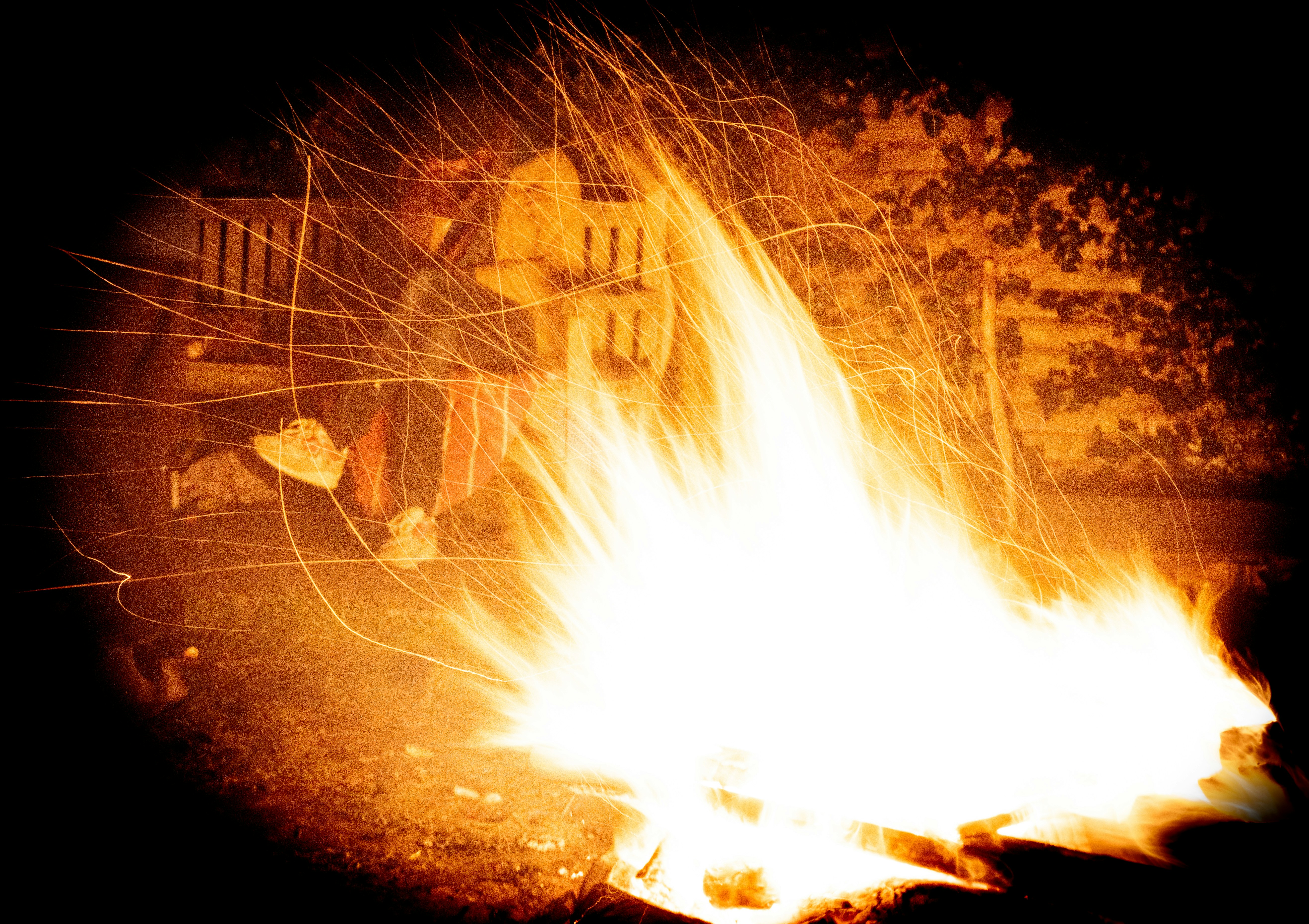 Sparks in Orbit: A Backyard Bonfire's Circular Firelight