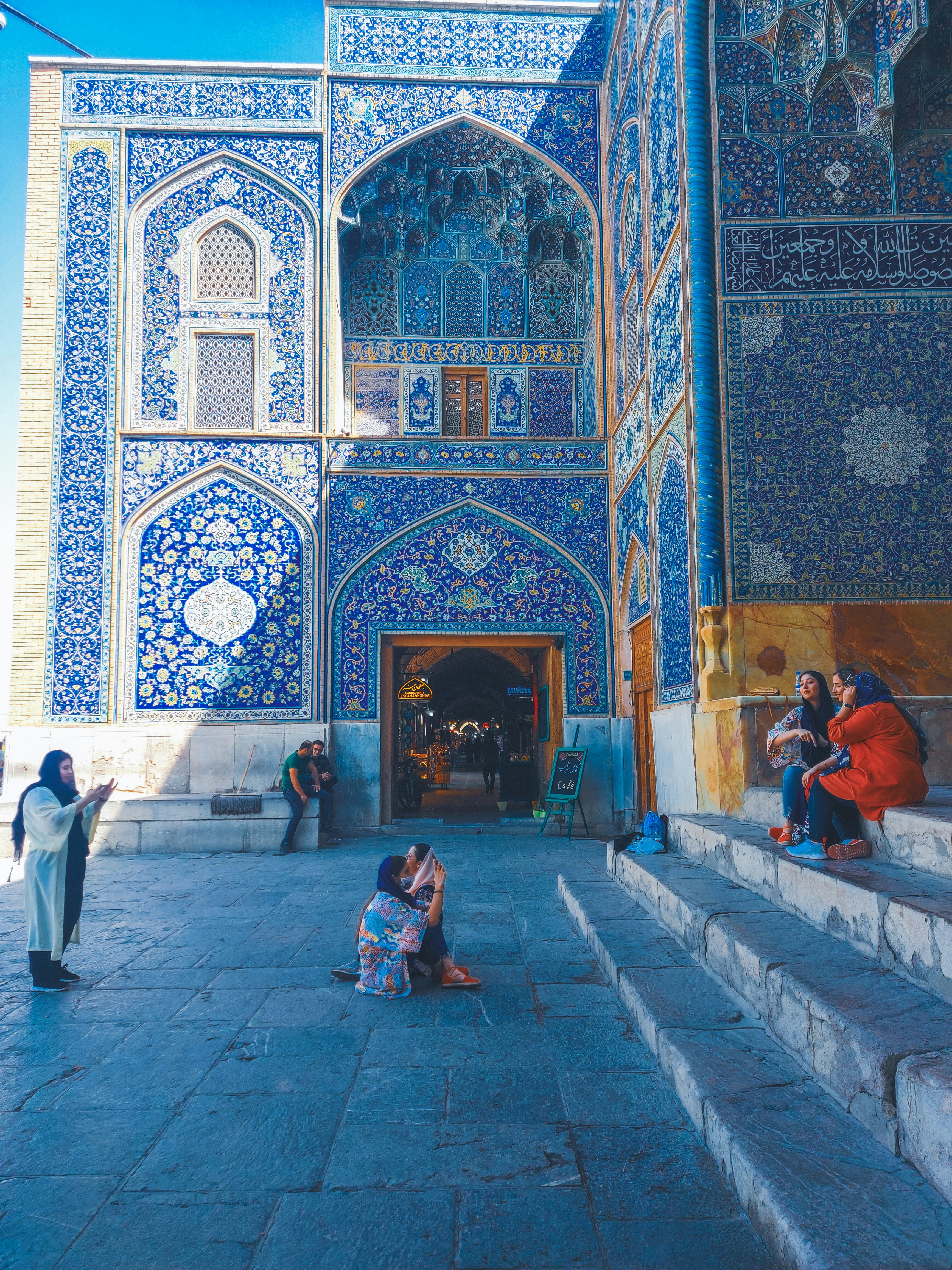 Blue Mosaic Portal: Visitors at the Imam Reza Shrine Courtyard