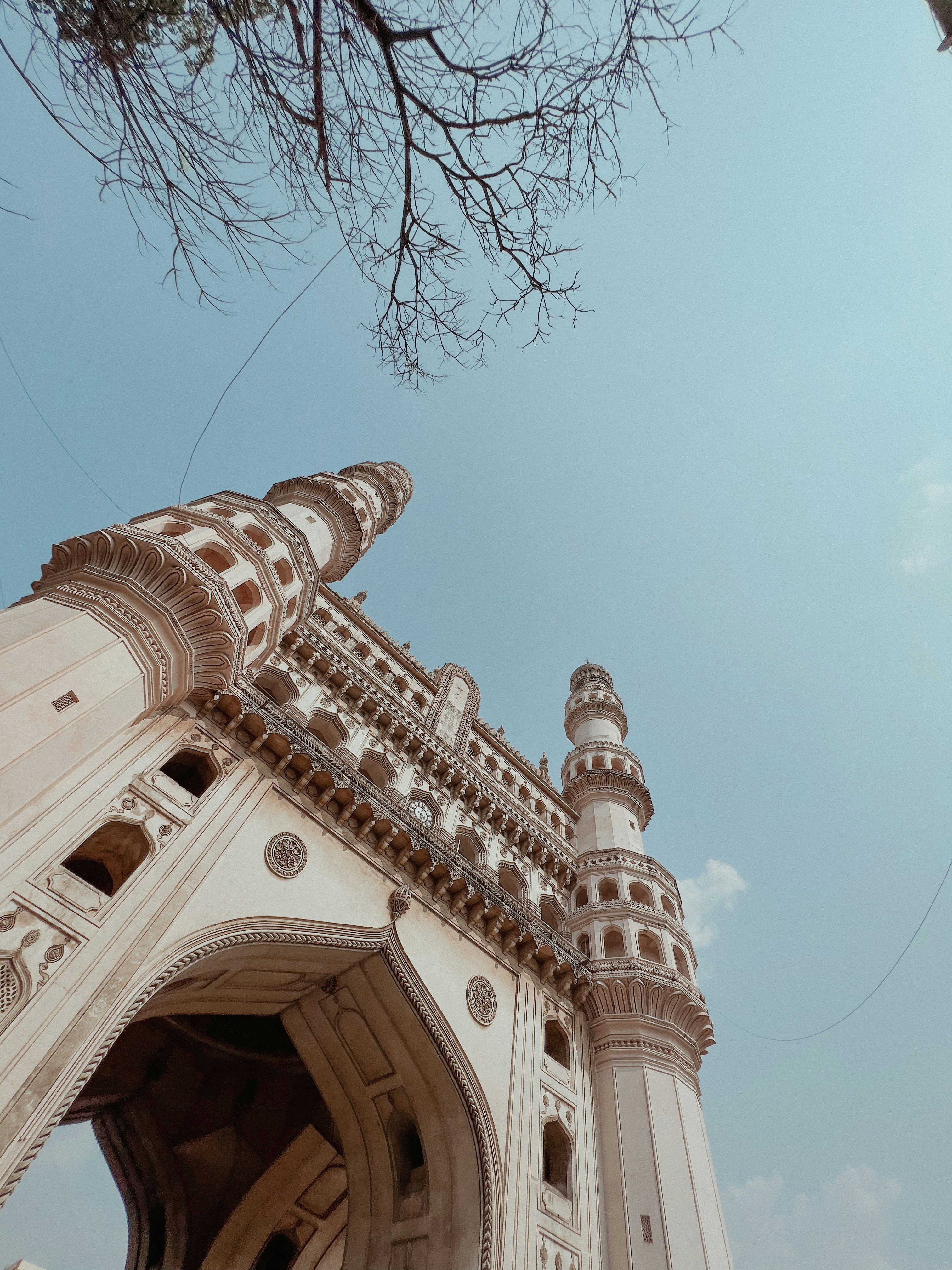 Intricate architectural details of a historical monument against a clear blue sky, showcasing the grandeur of cultural heritage.