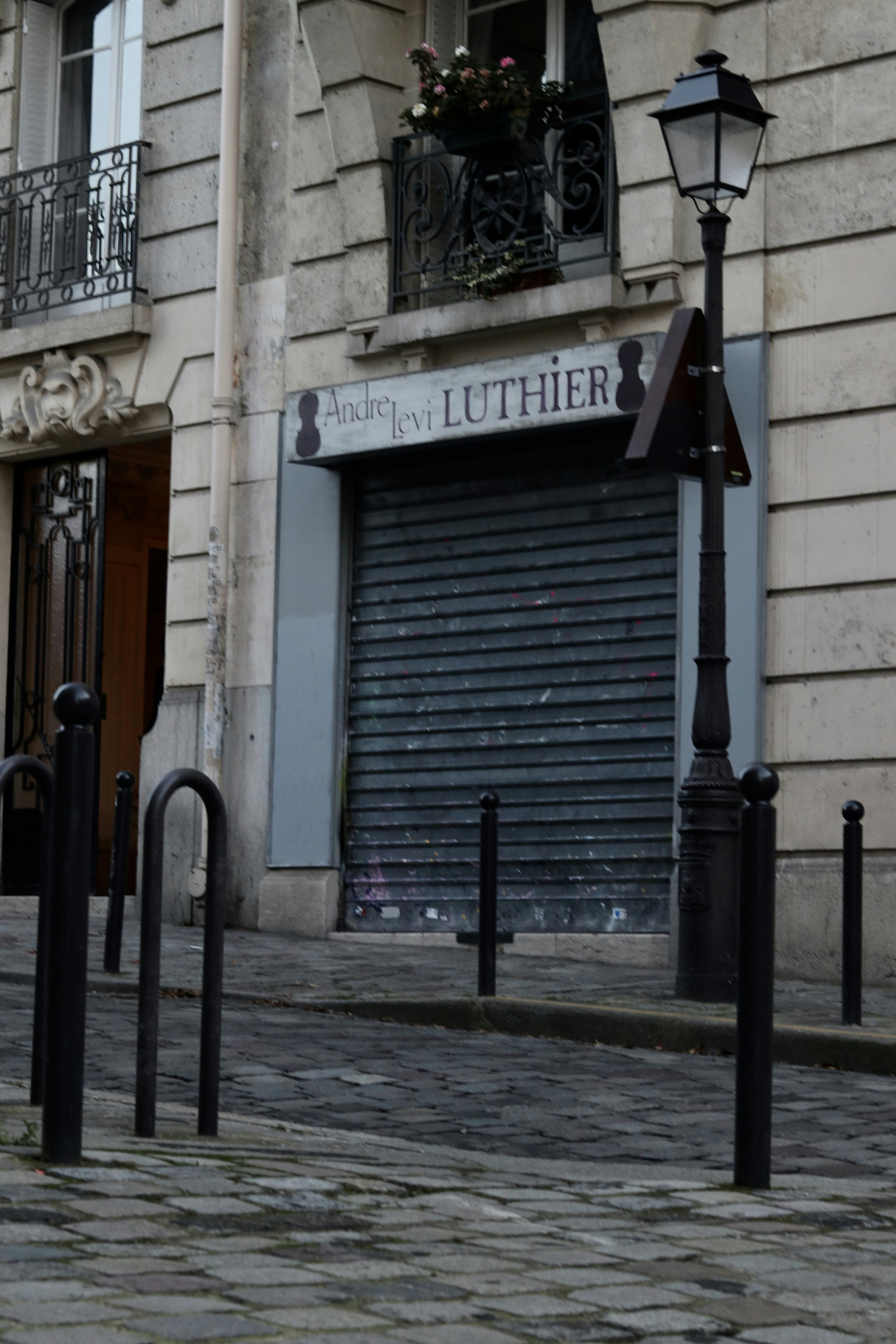 Closed storefront under a European streetlamp