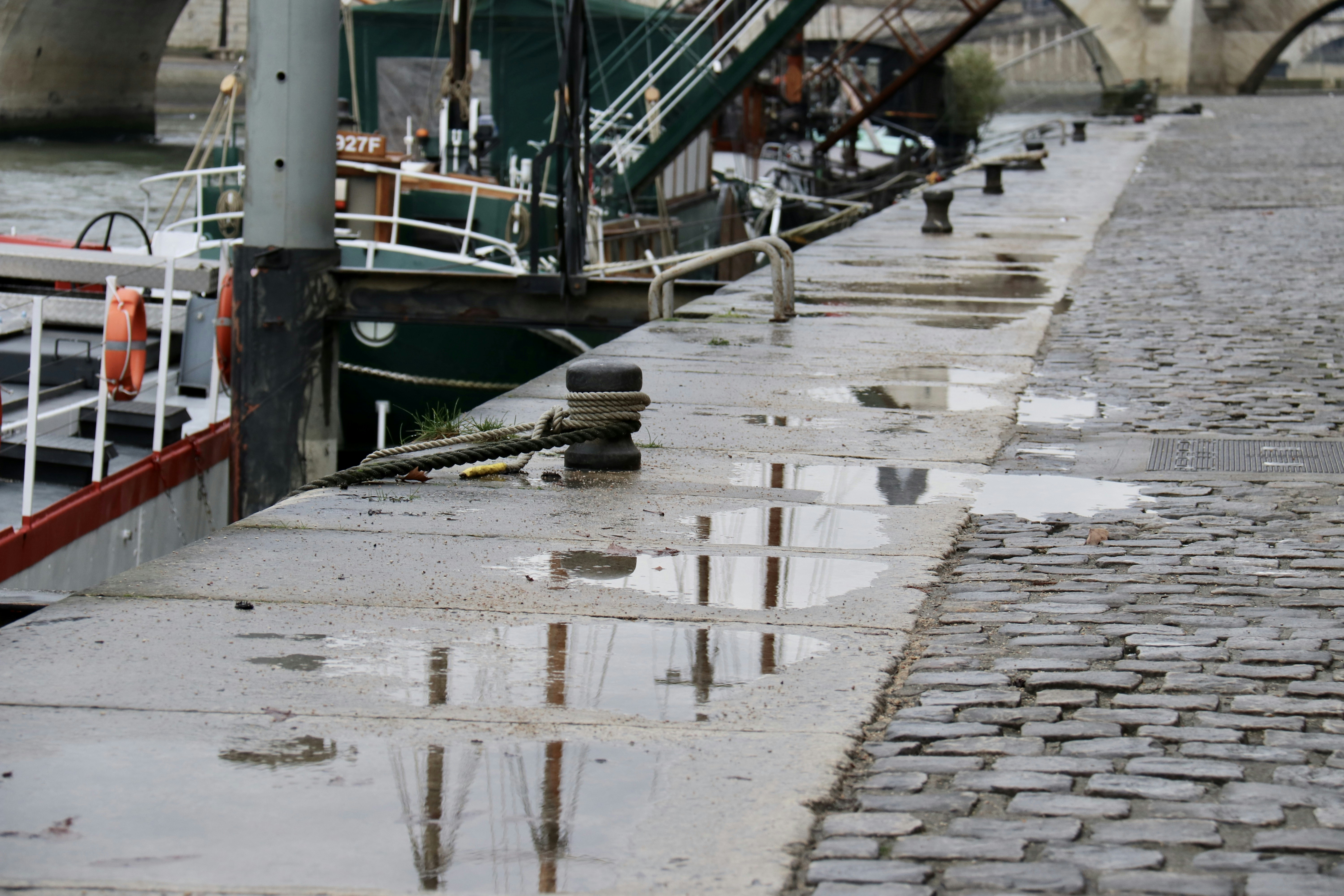Quay Reflections: Rain-Wet Harbor Walk