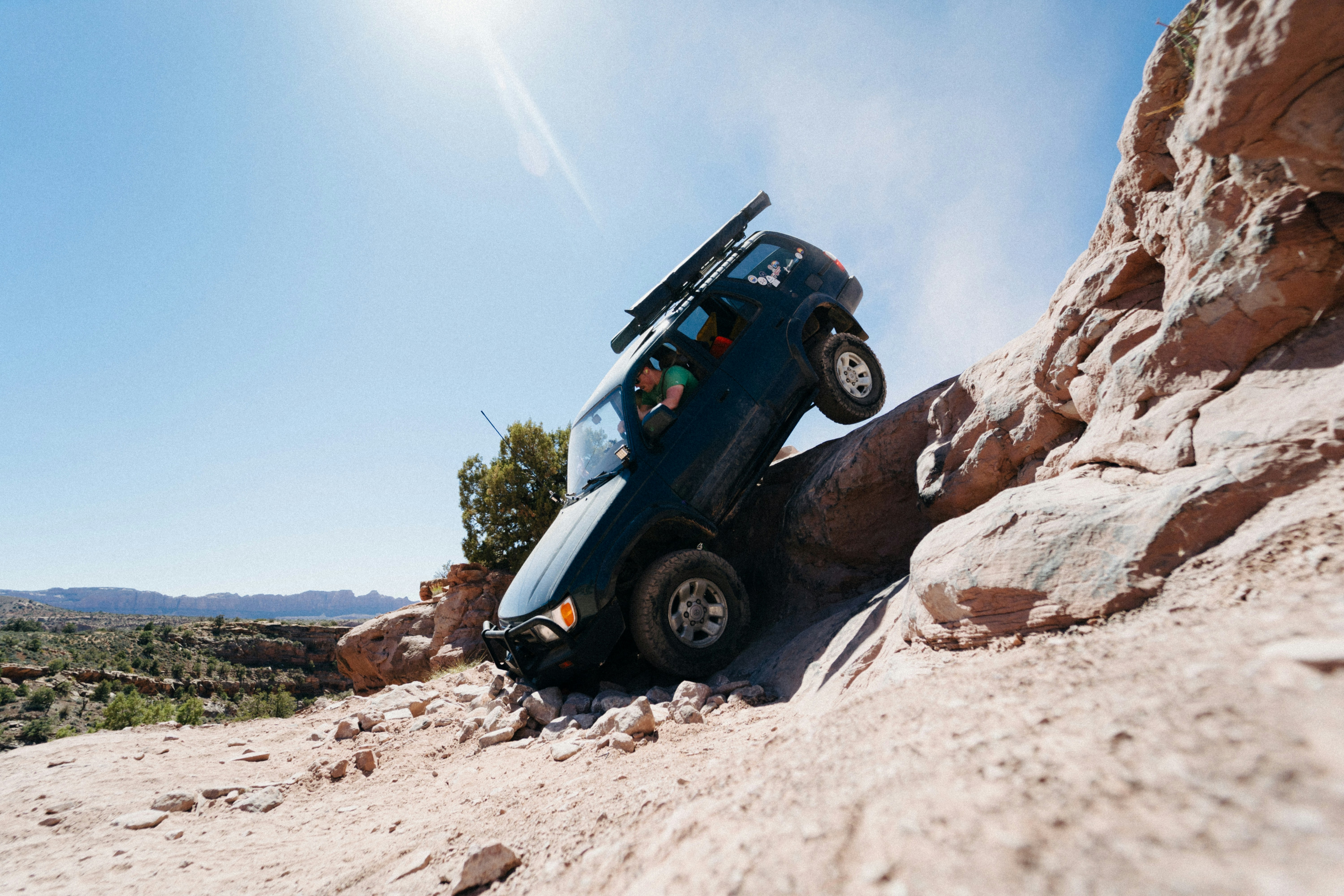 Cliffside Descent: A Jeep-turned-ascension on sunlit sandstone