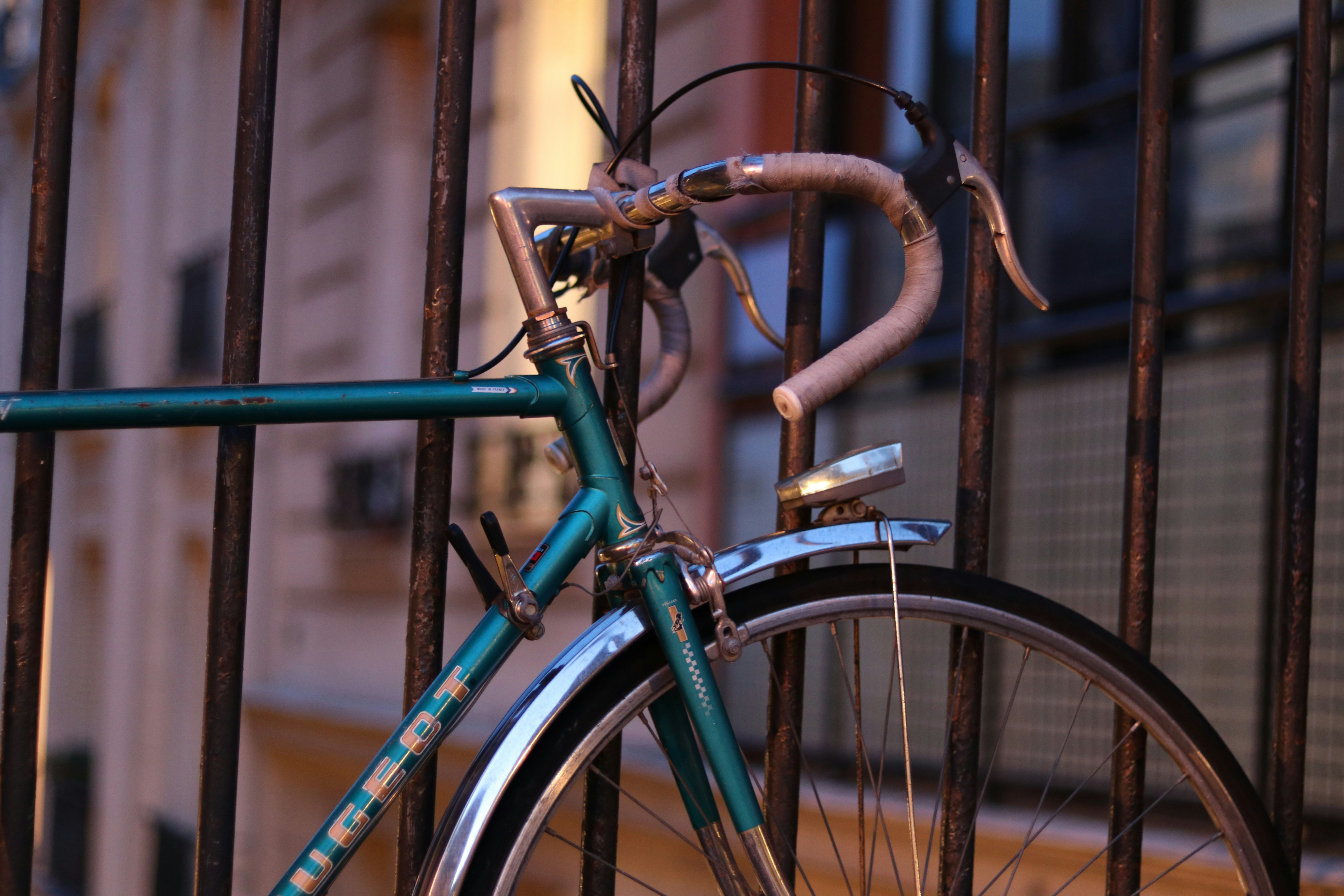 a bicycle parked in a fence