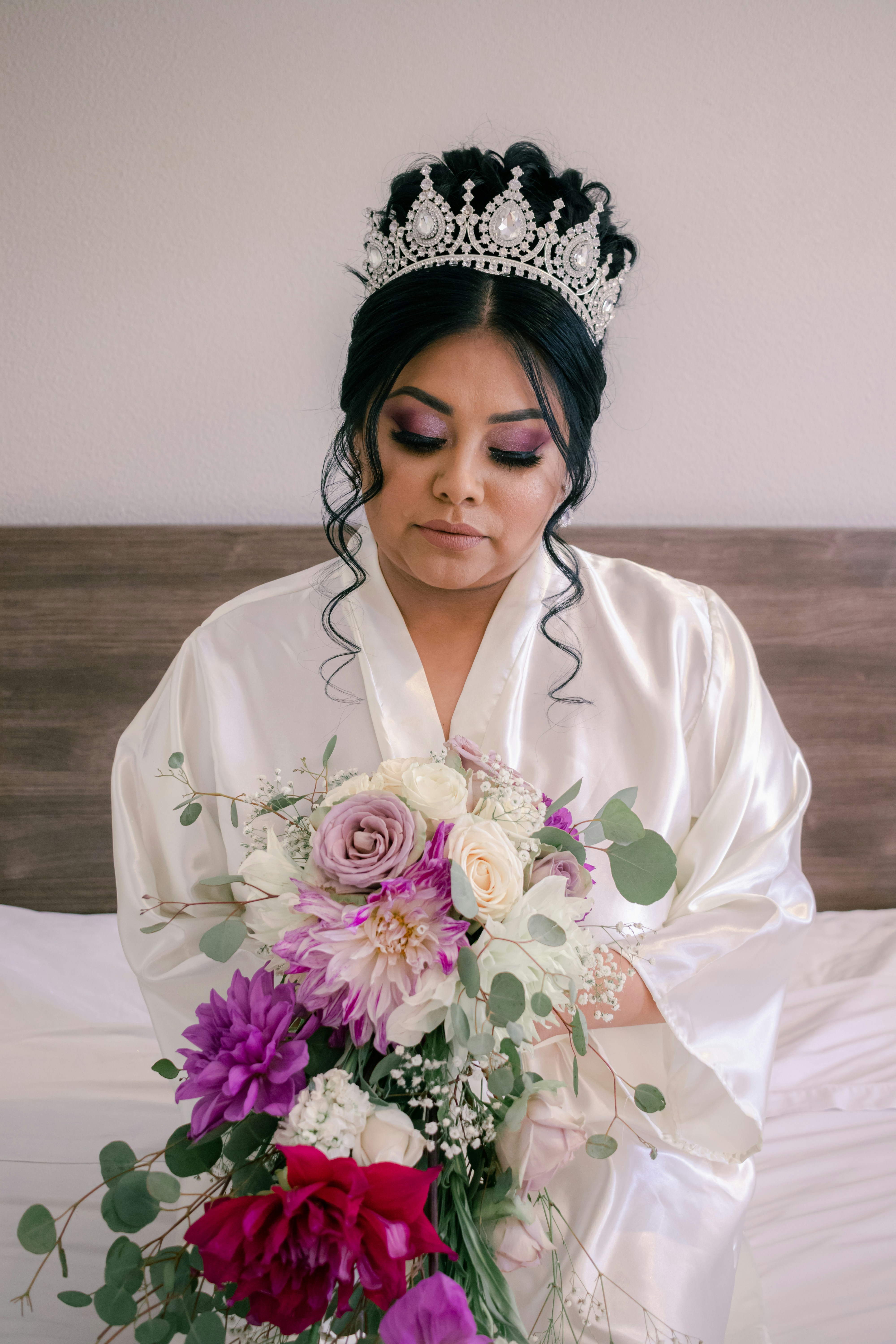 Regal Quiet: Bride in a Crowned Moment with Cascading Blooms