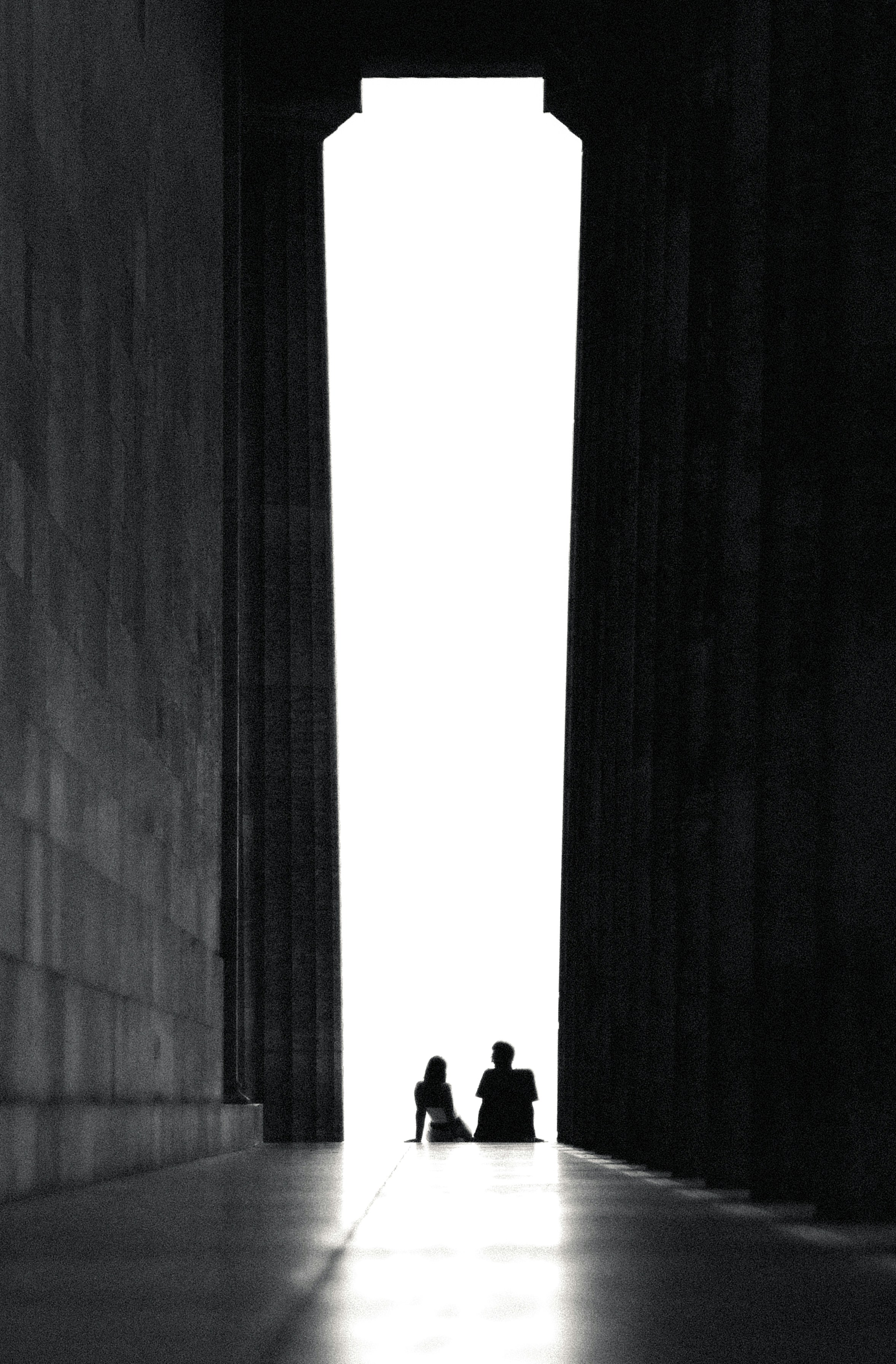 Light at the Threshold: Silhouettes Beneath a Narrow Arch
