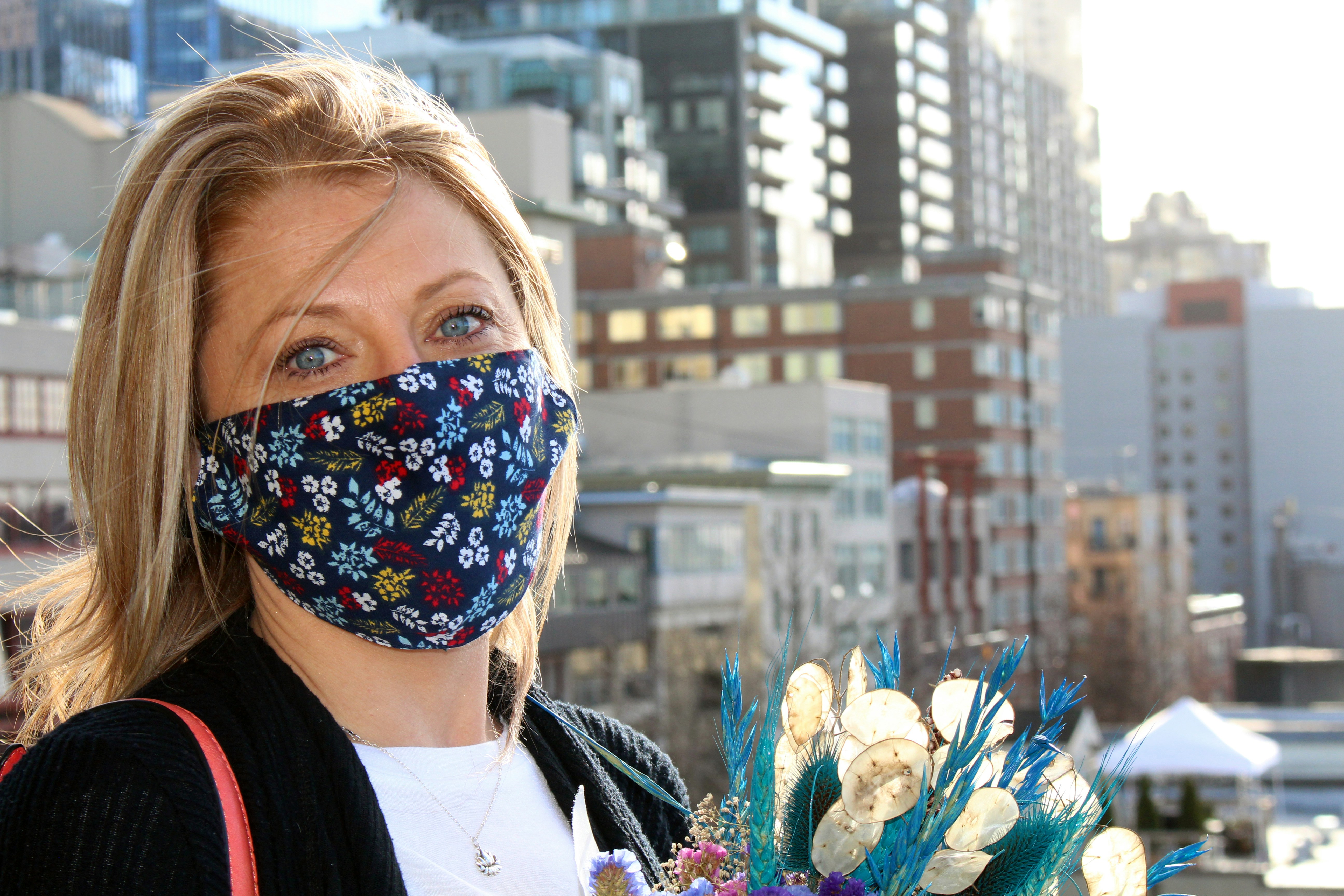 Masked Portrait Amid Urban Rooftop Bloom
