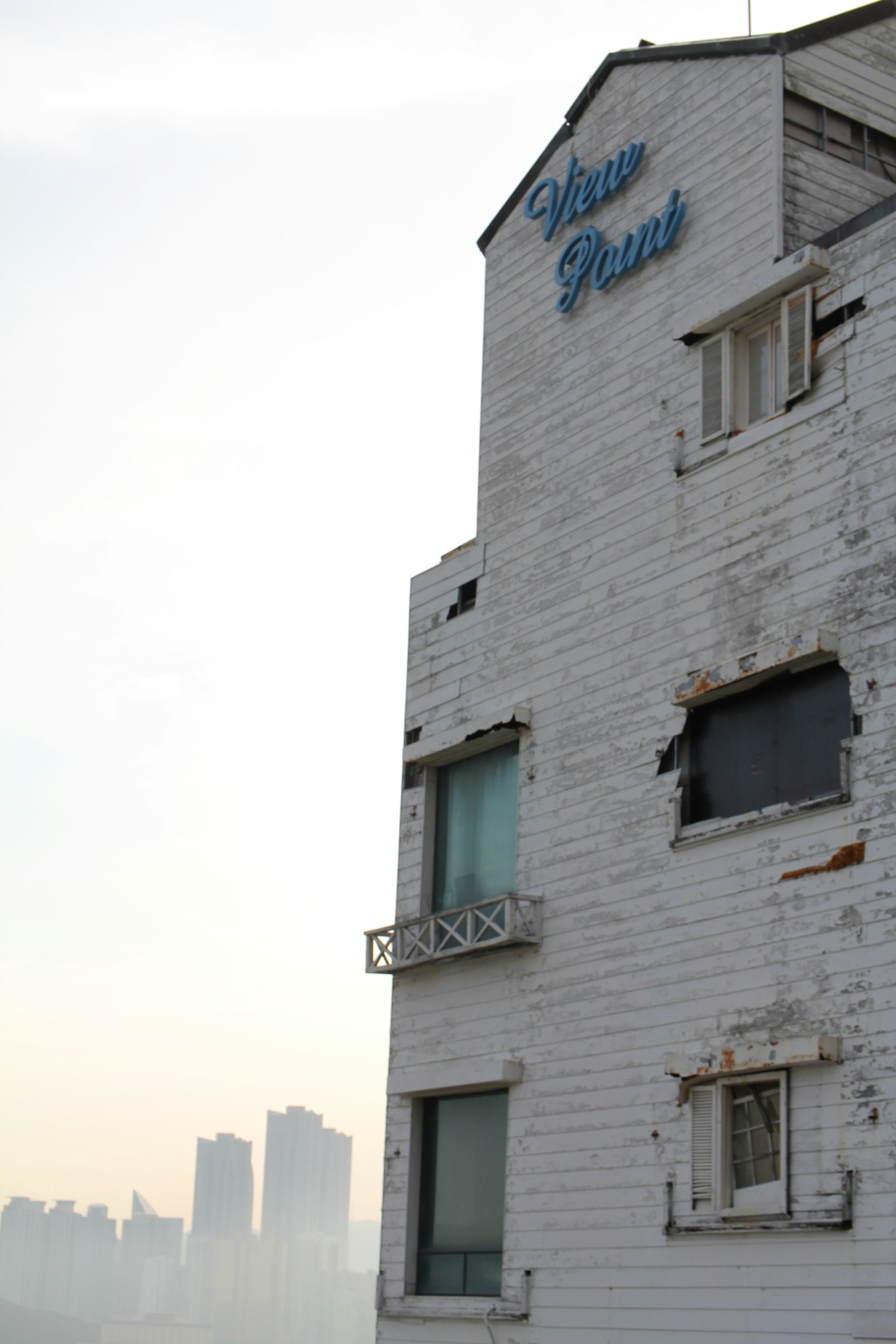 View Point Tower: A Weathered Facade Framing a Distant Skyline