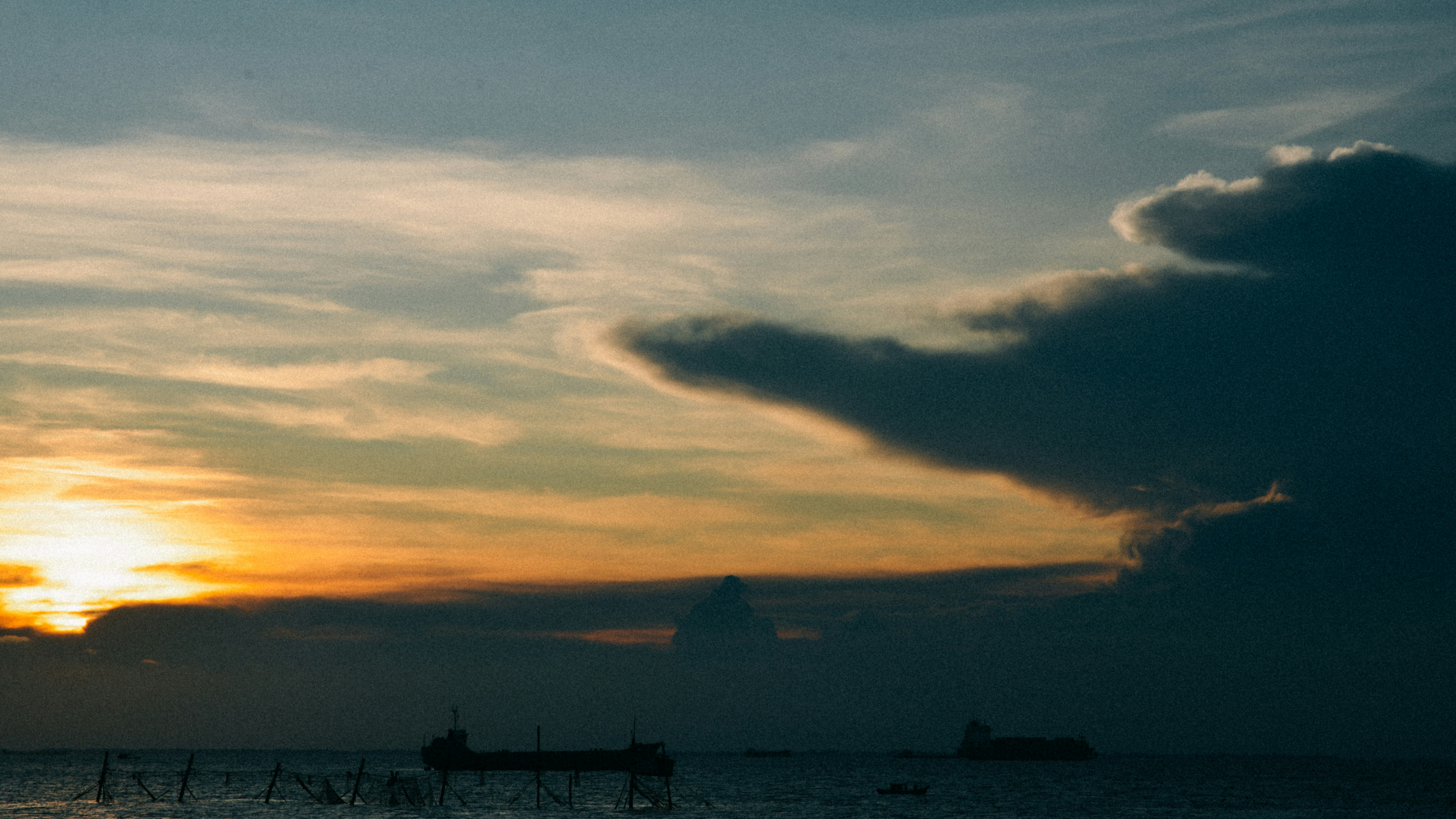 Dawn’s Quiet Edge: Sunlit Horizon and Shadowed Freighters