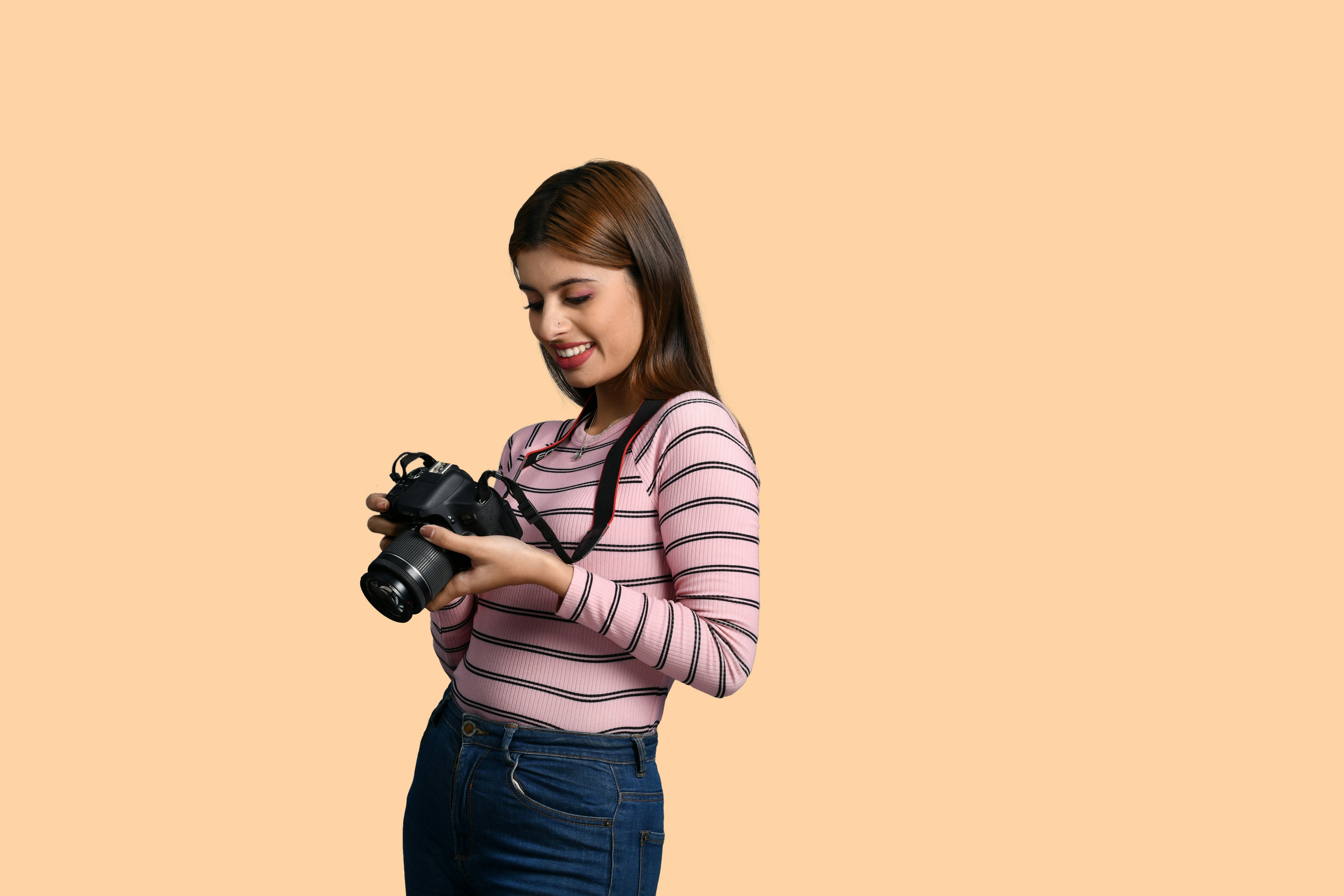 Portrait of a Photographer: Soft Peach Backdrop and Focused Gaze