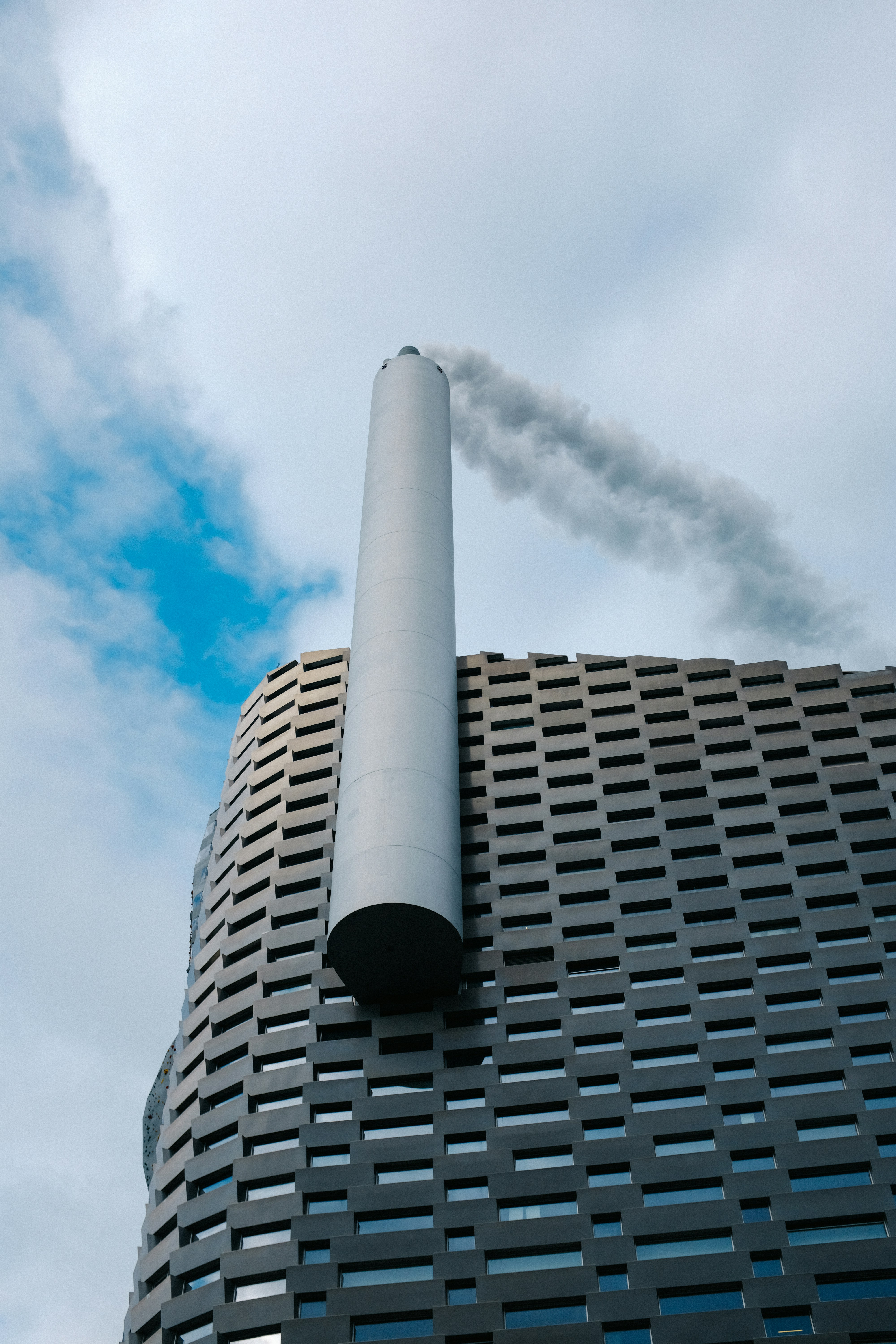 A tall building with smoke coming out of it photo – Free Vehicle Image ...