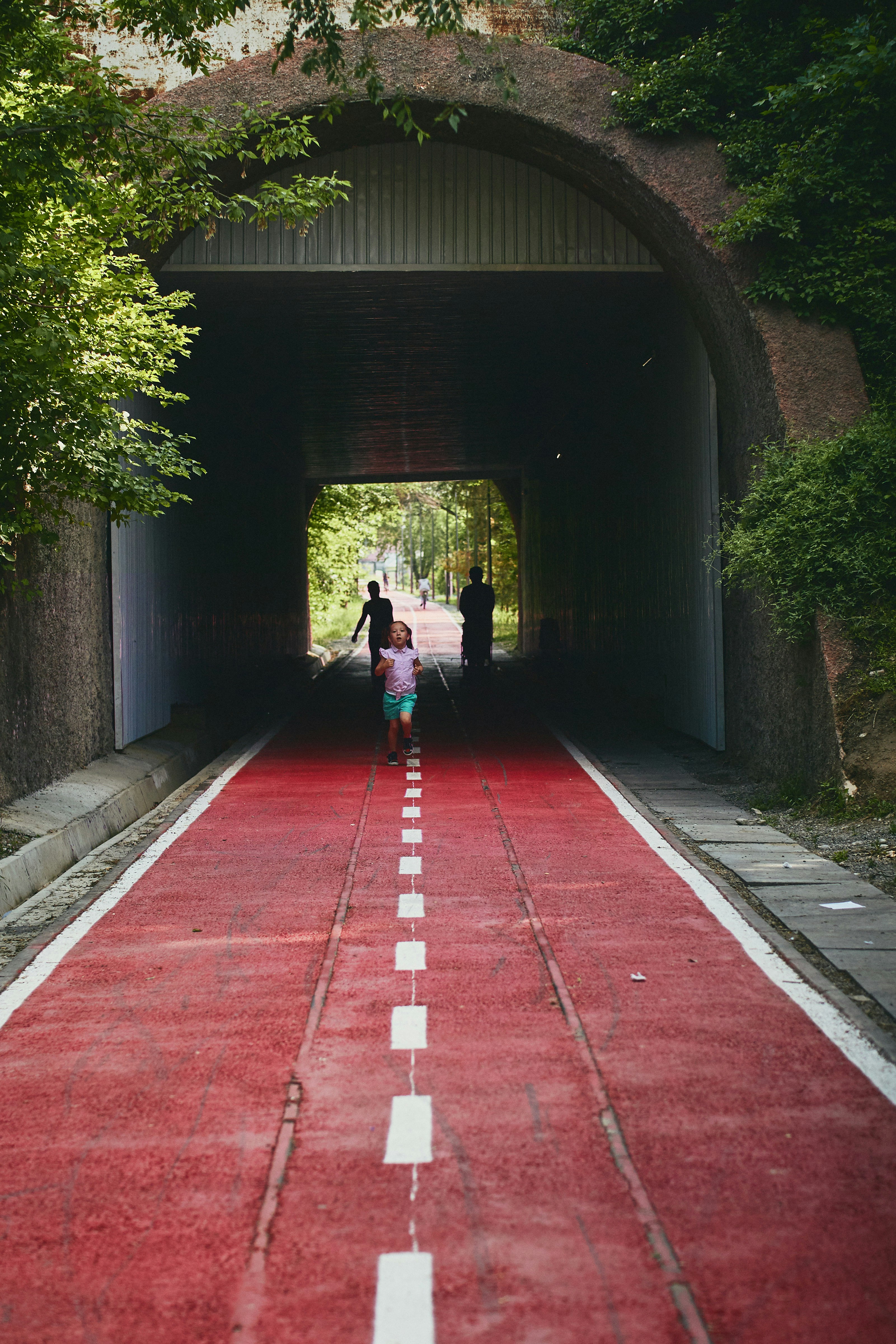 A group of people walking through a tunnel photo – Free Path Image on ...