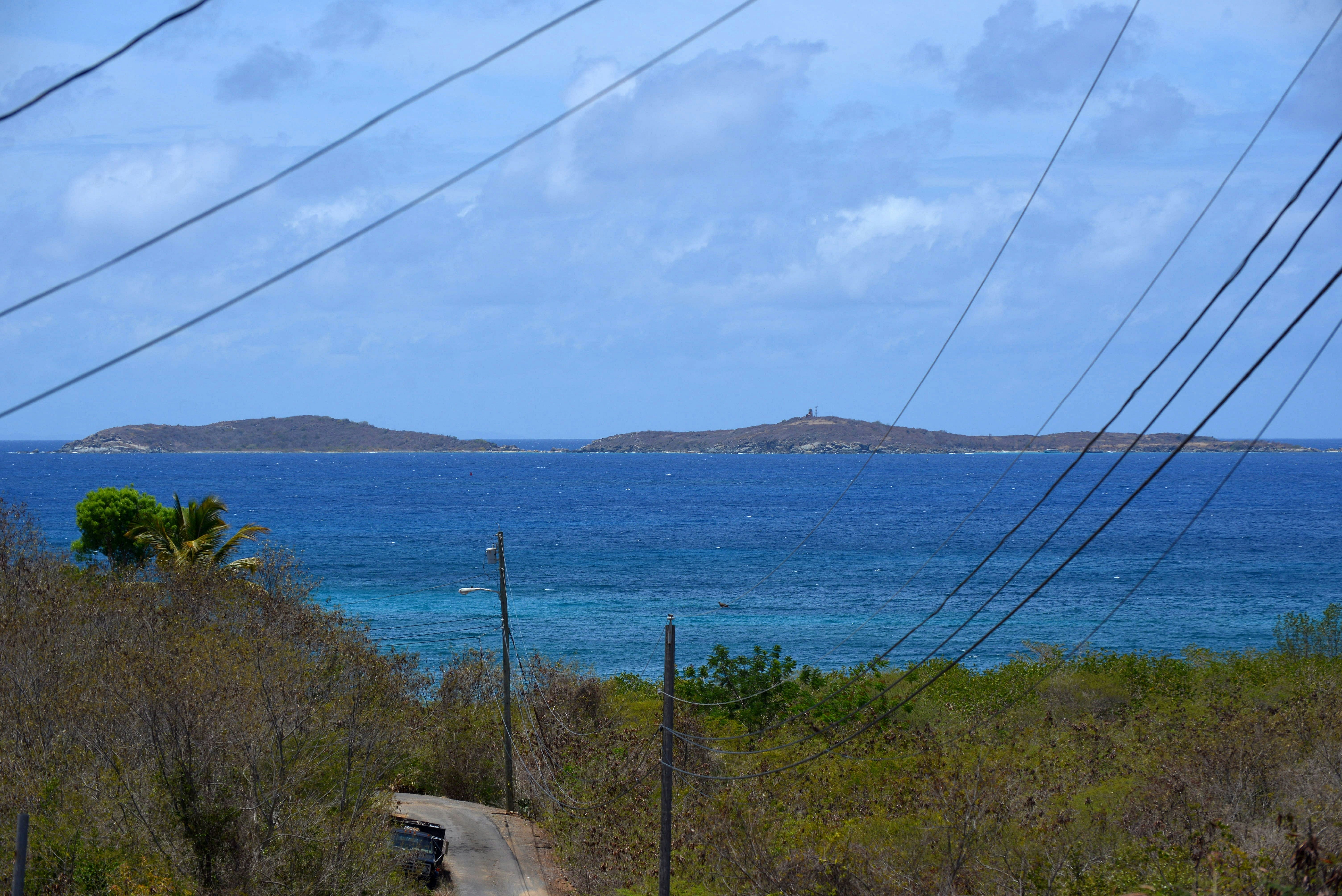 Coastal Flats and Distant Islands under a Woven Sky