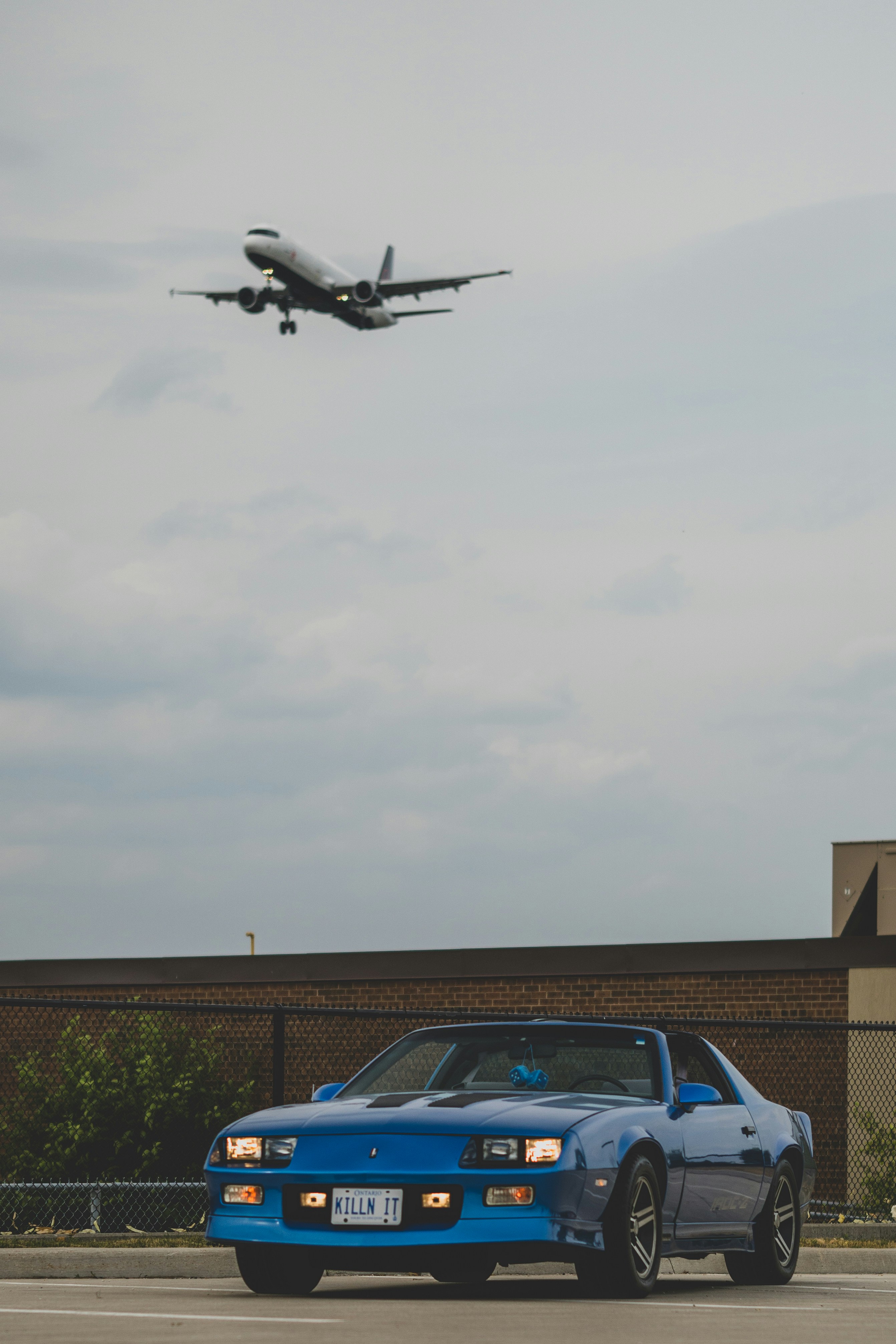 Blue Roadster Under an Approaching Jet: A Parking-Lot Panorama