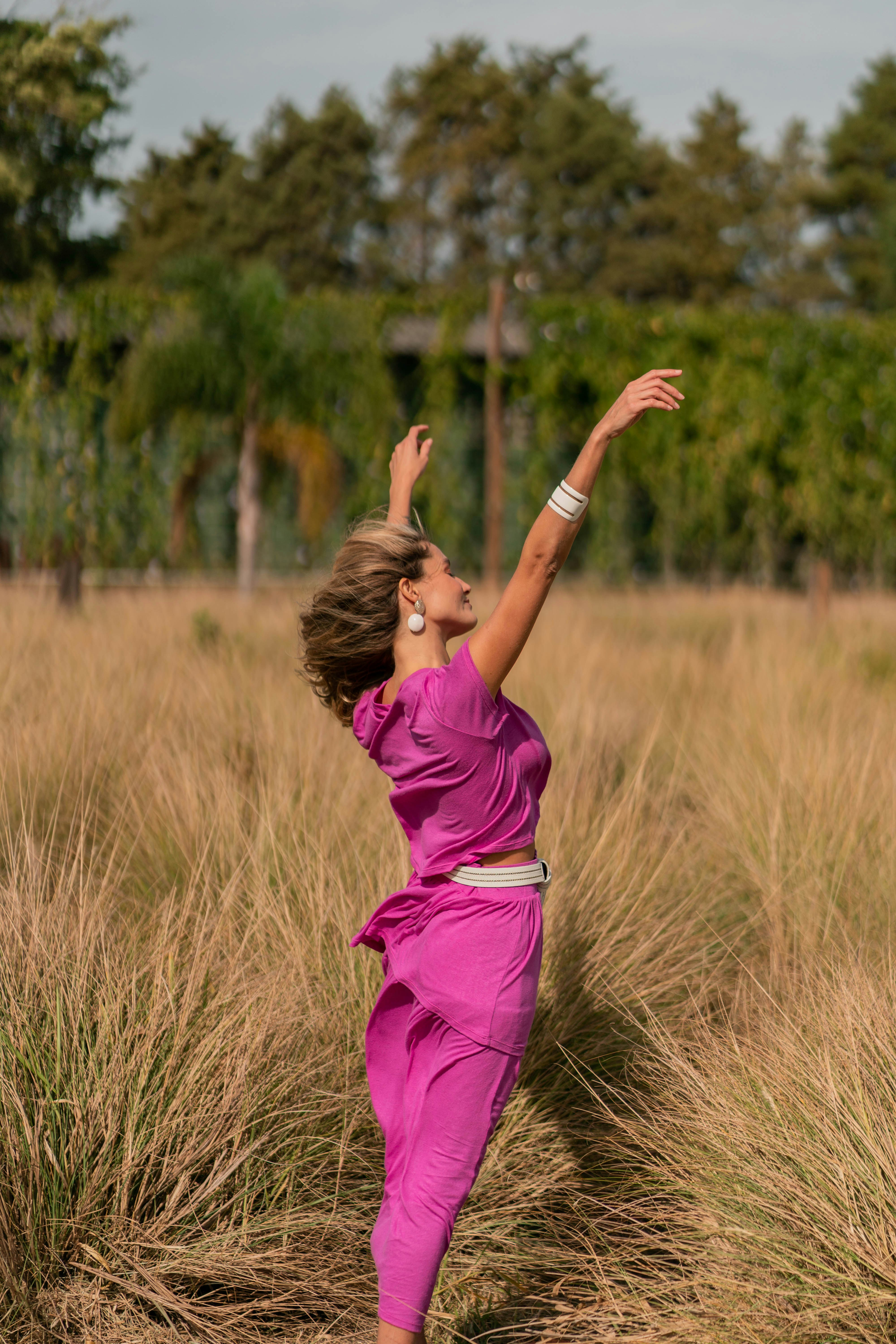 Pink in the Prairie: A dancer’s reach against golden grasses