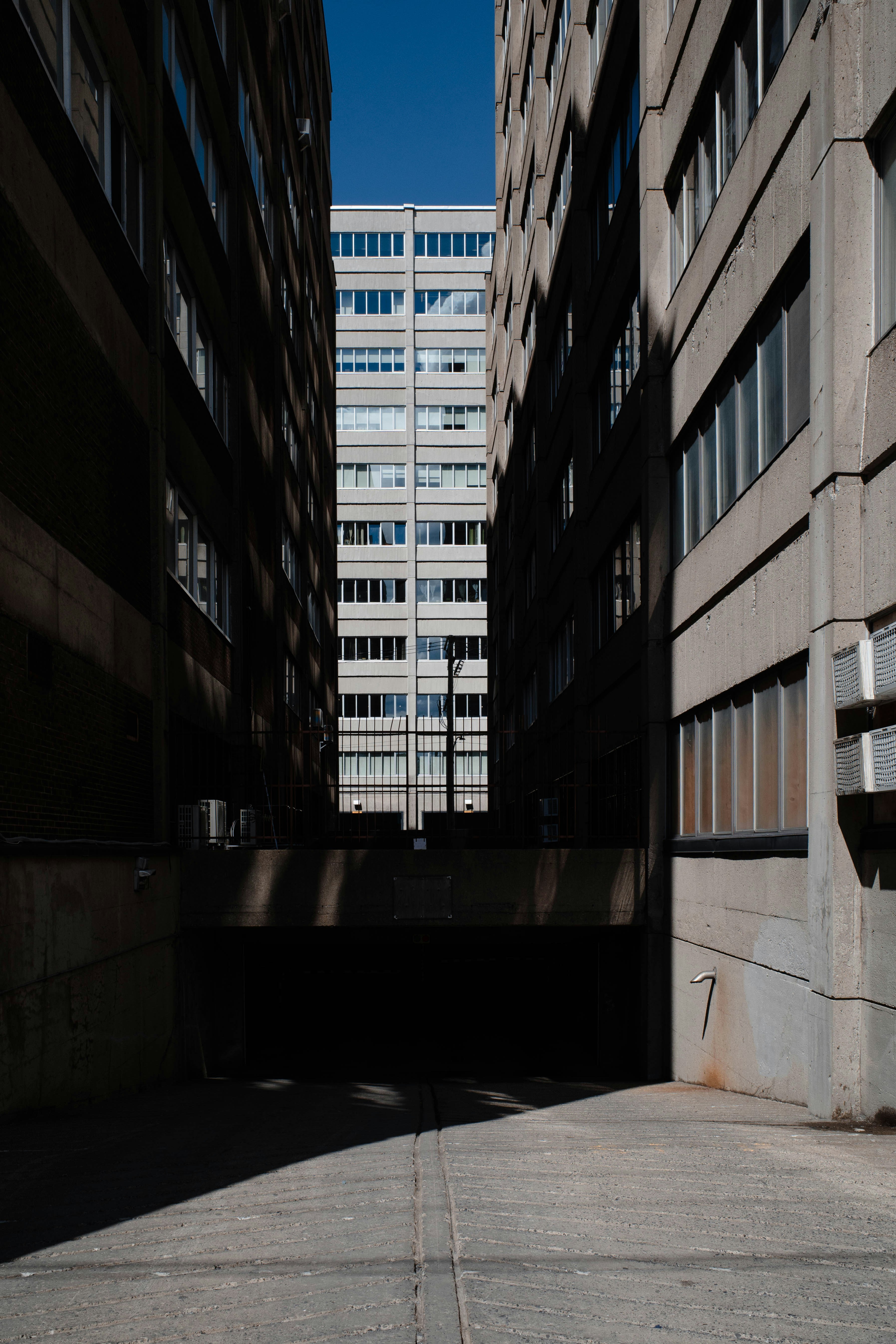 A building with a walkway between two buildings photo – Free Street ...