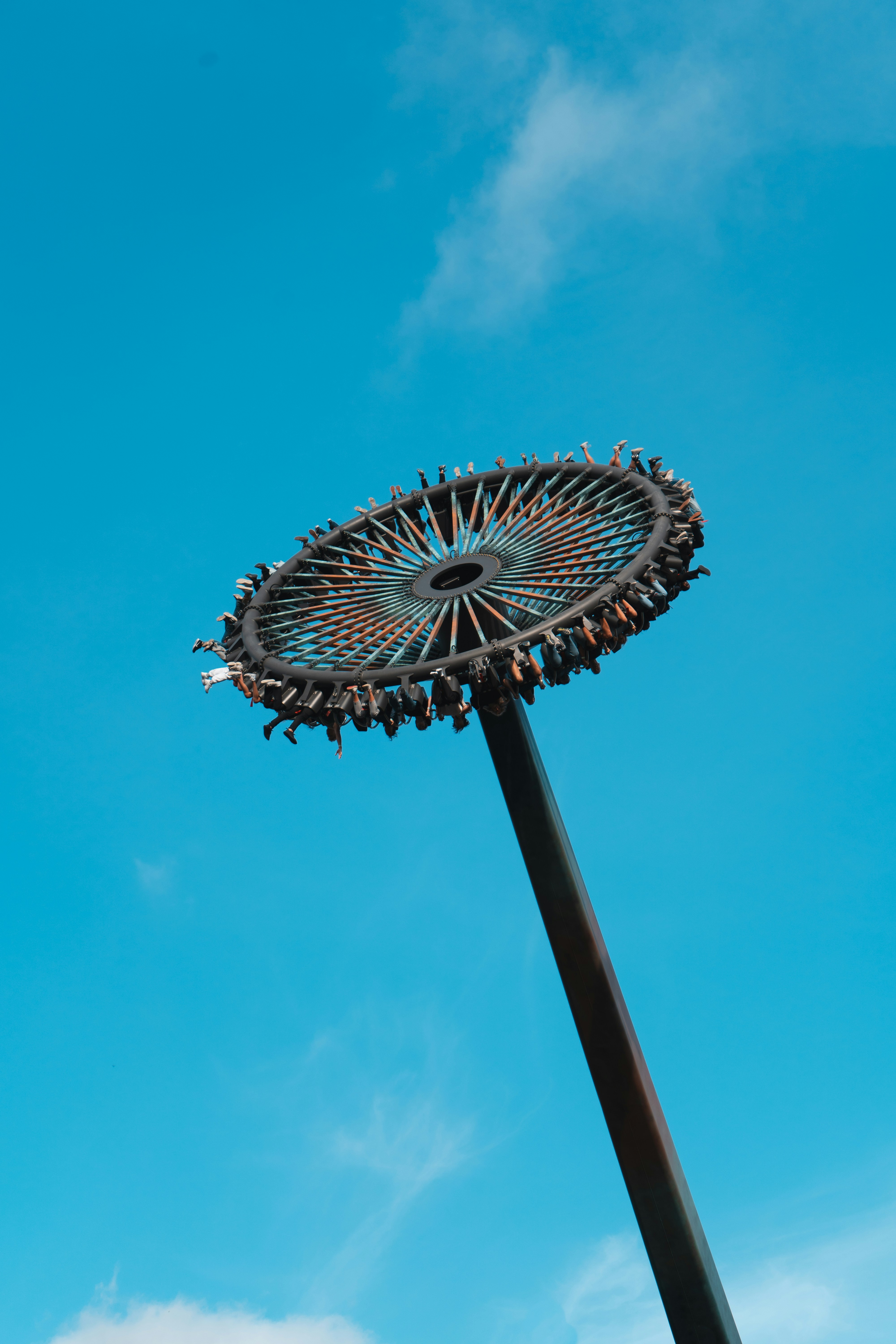 Rising Ring: A Circular Carousel Seen from Below Against a Pristine Blue Sky