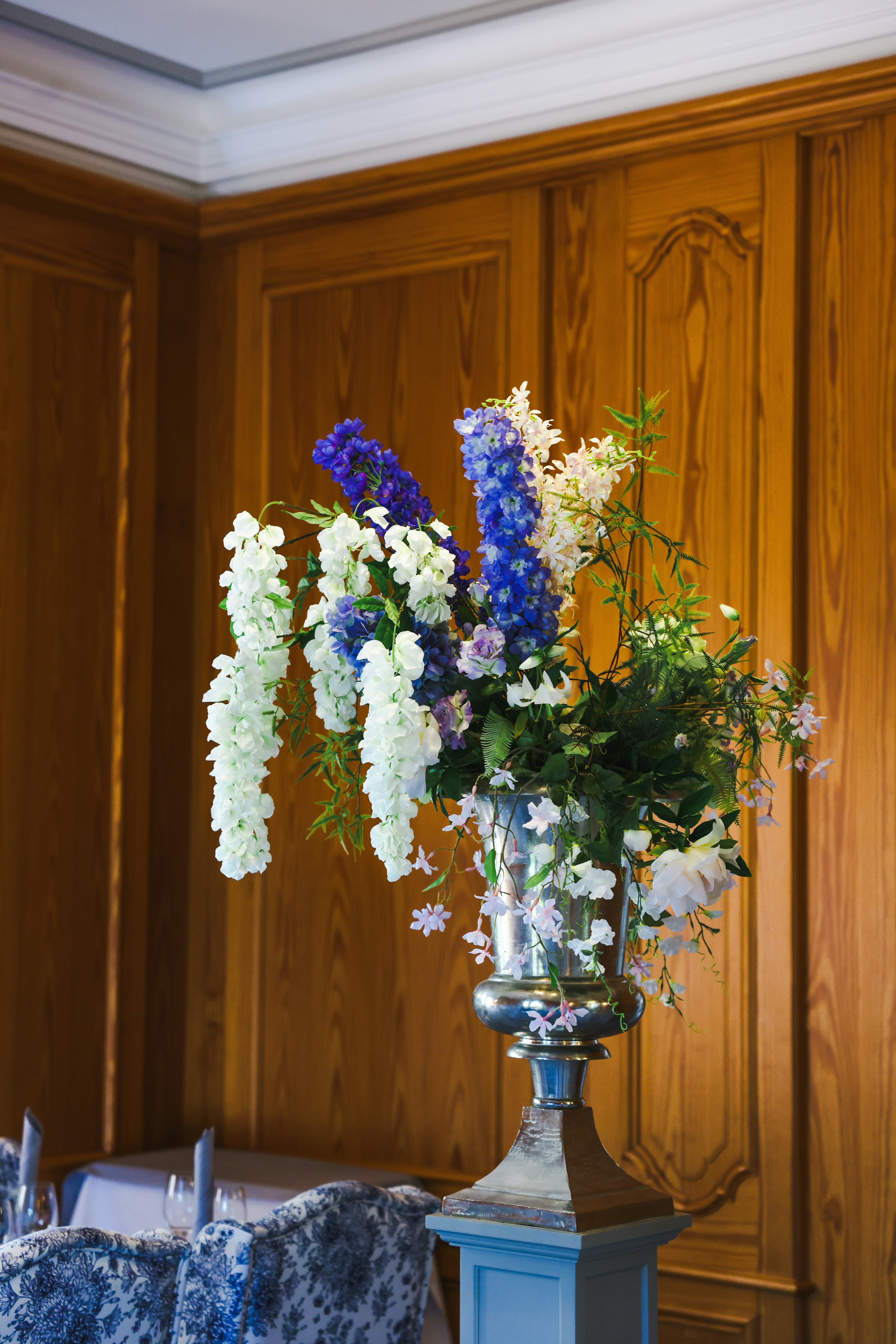 Azure Spires in a Walnut Hall: Floral Ode on a Silver Pedestal