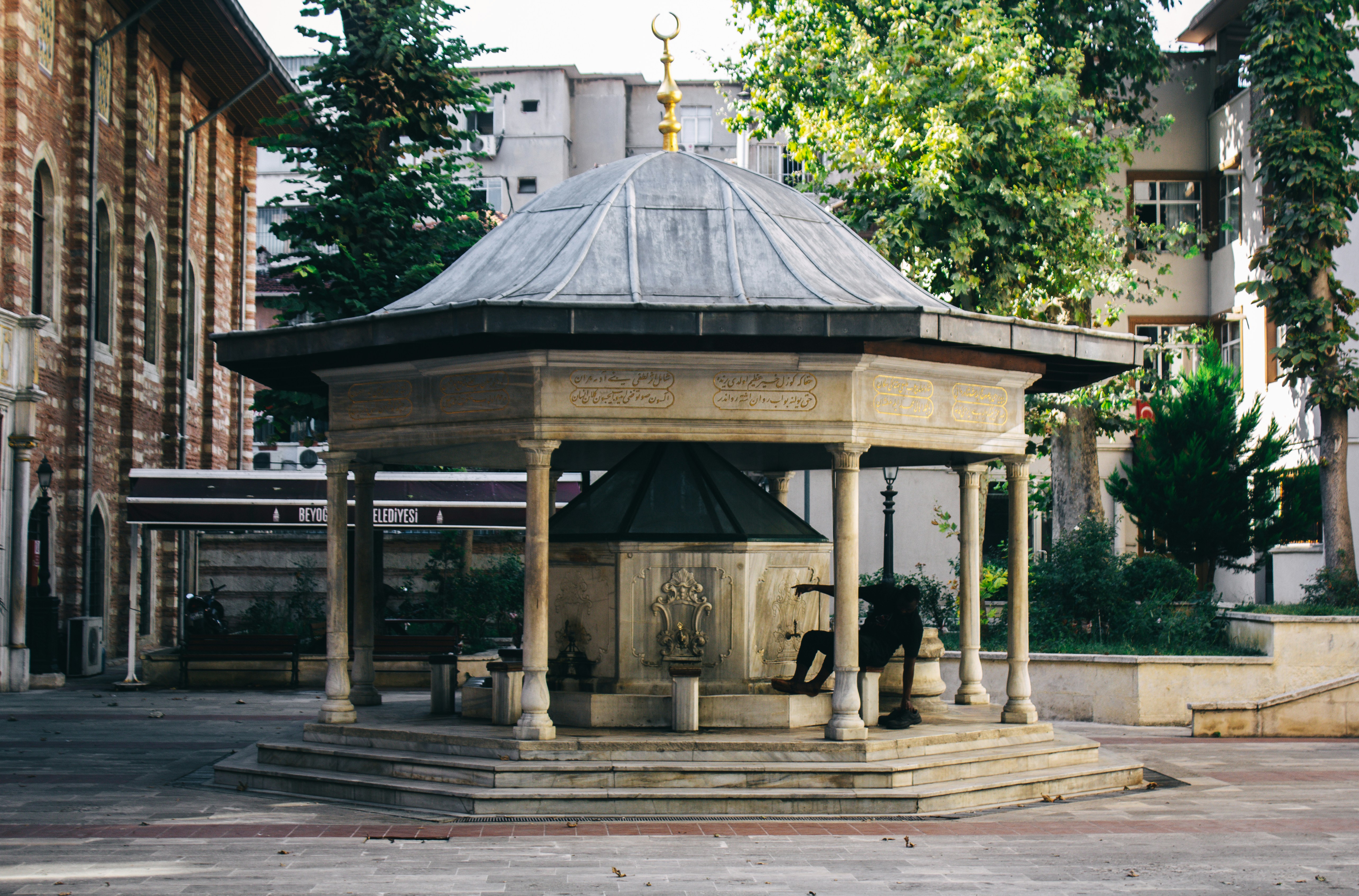 Sunlit Center: The Stone Pavilion and Fountain in a Quiet Courtyard