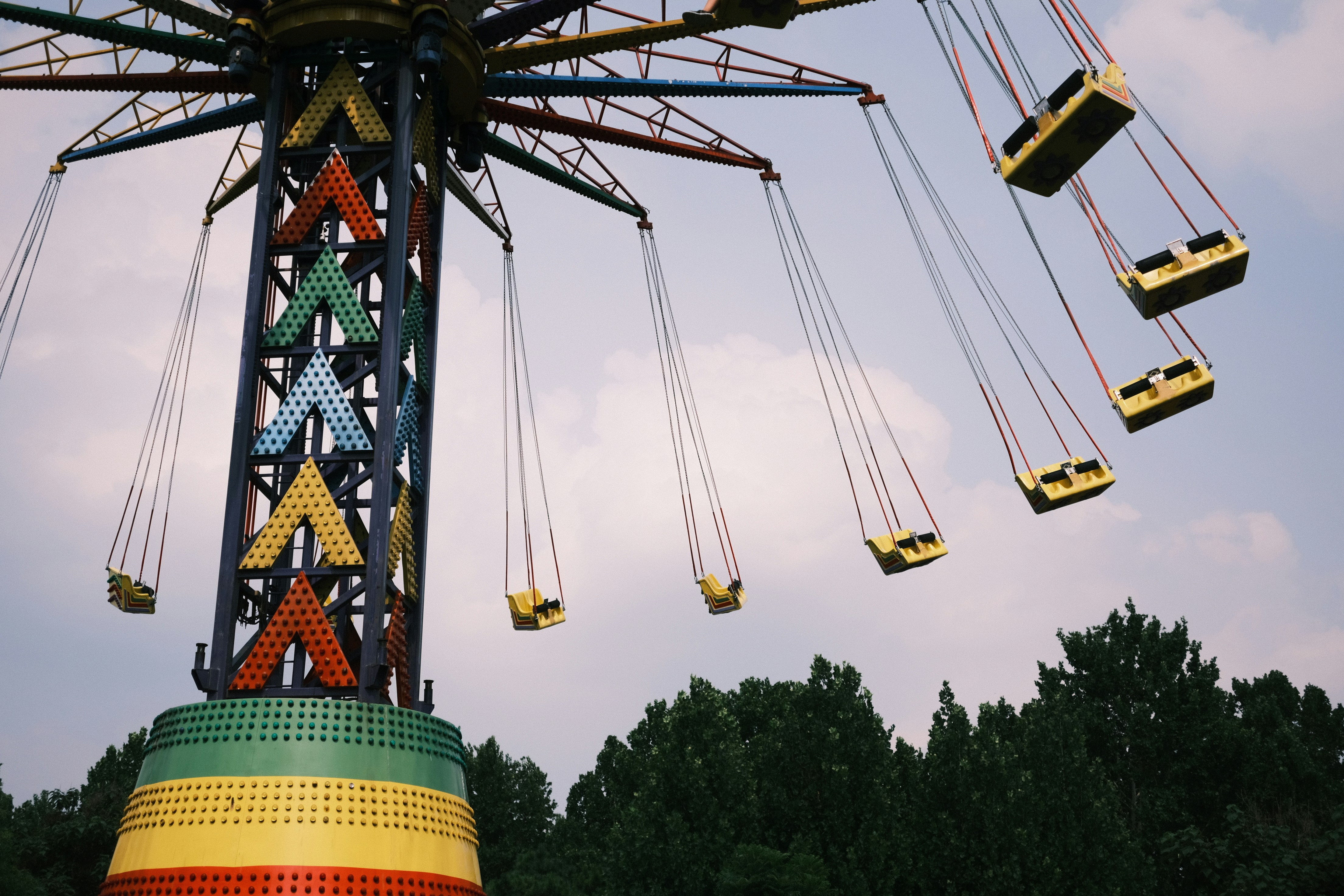 A roller coaster with trees in the background photo – Free Park Image ...