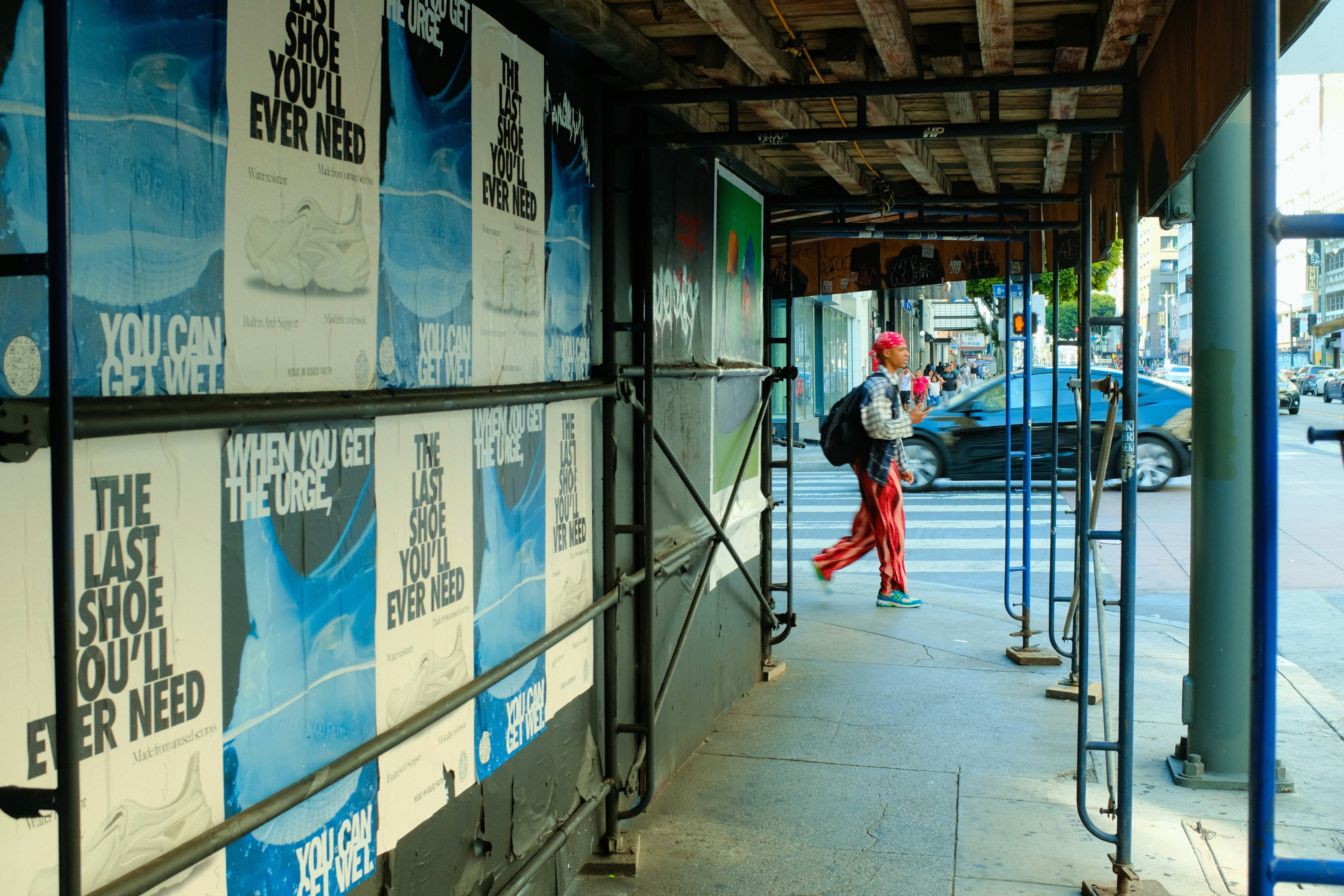 Crosswalk Window: A Pedestrian Steps Through Construction Shade