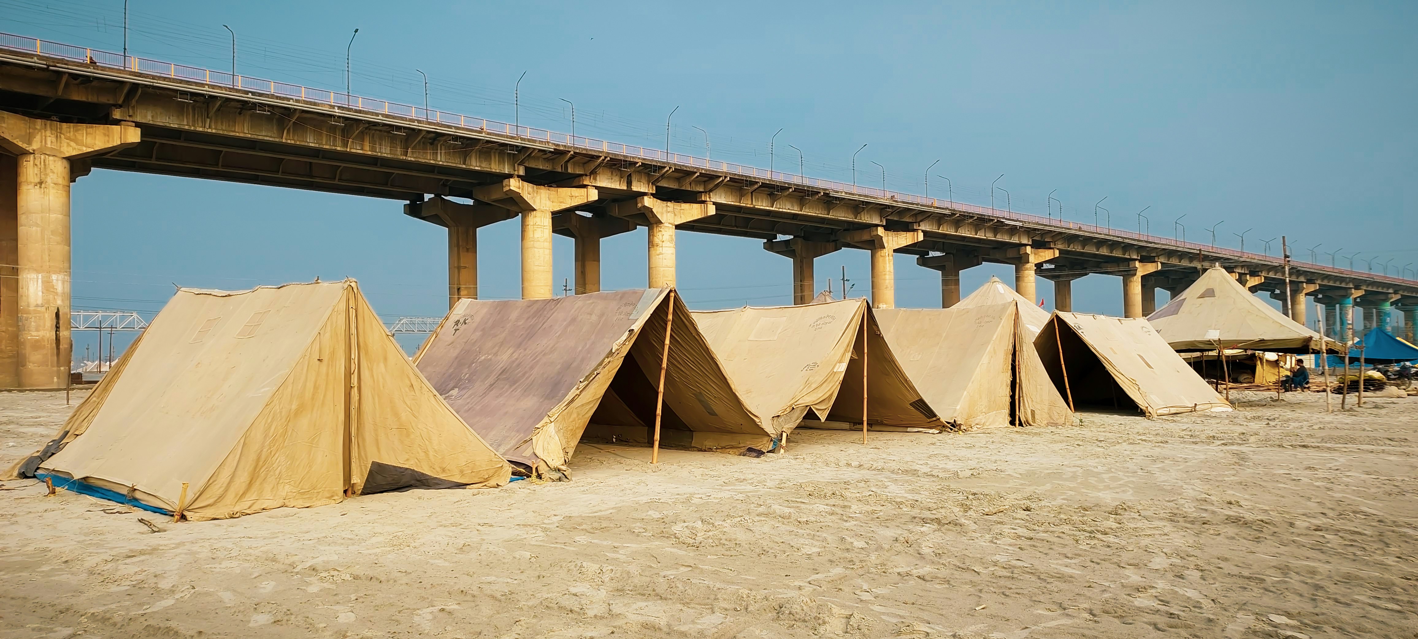 A bridge with a group of tents photo – Free Sangam tents Image on Unsplash