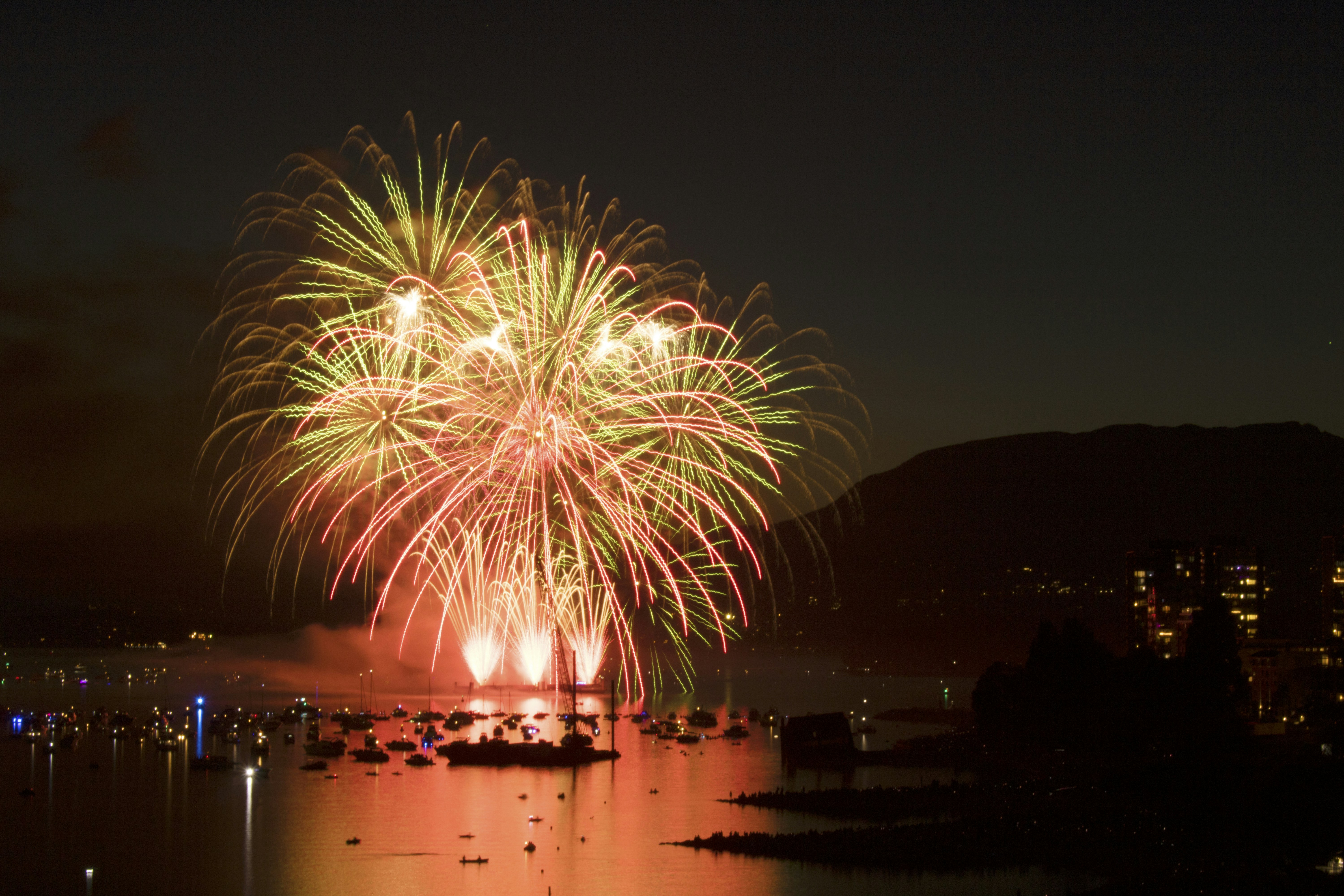 Fireworks Bloom Over a Quiet Marina at Night