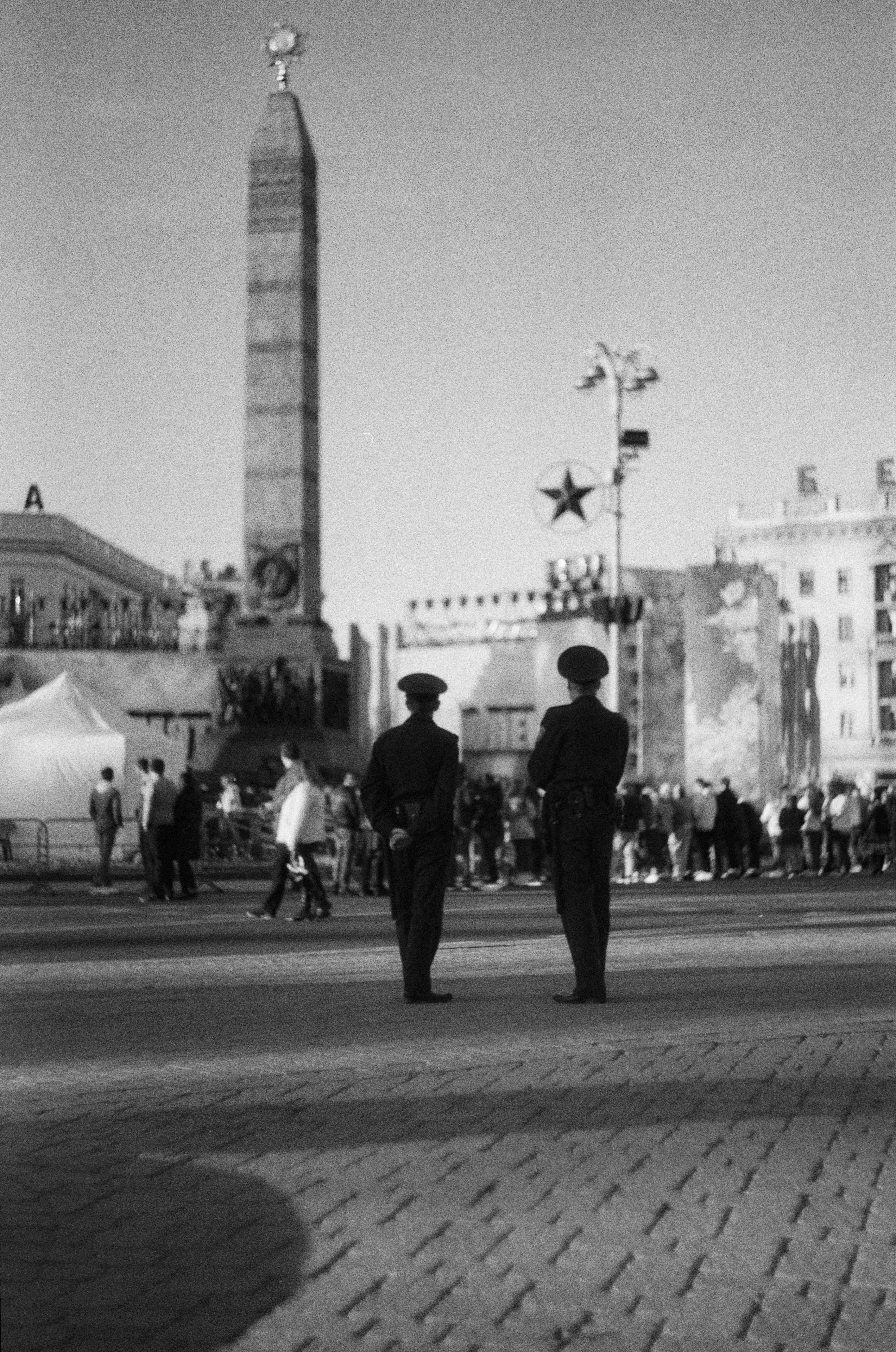 A group of men in uniform standing in front of a tall monument photo ...