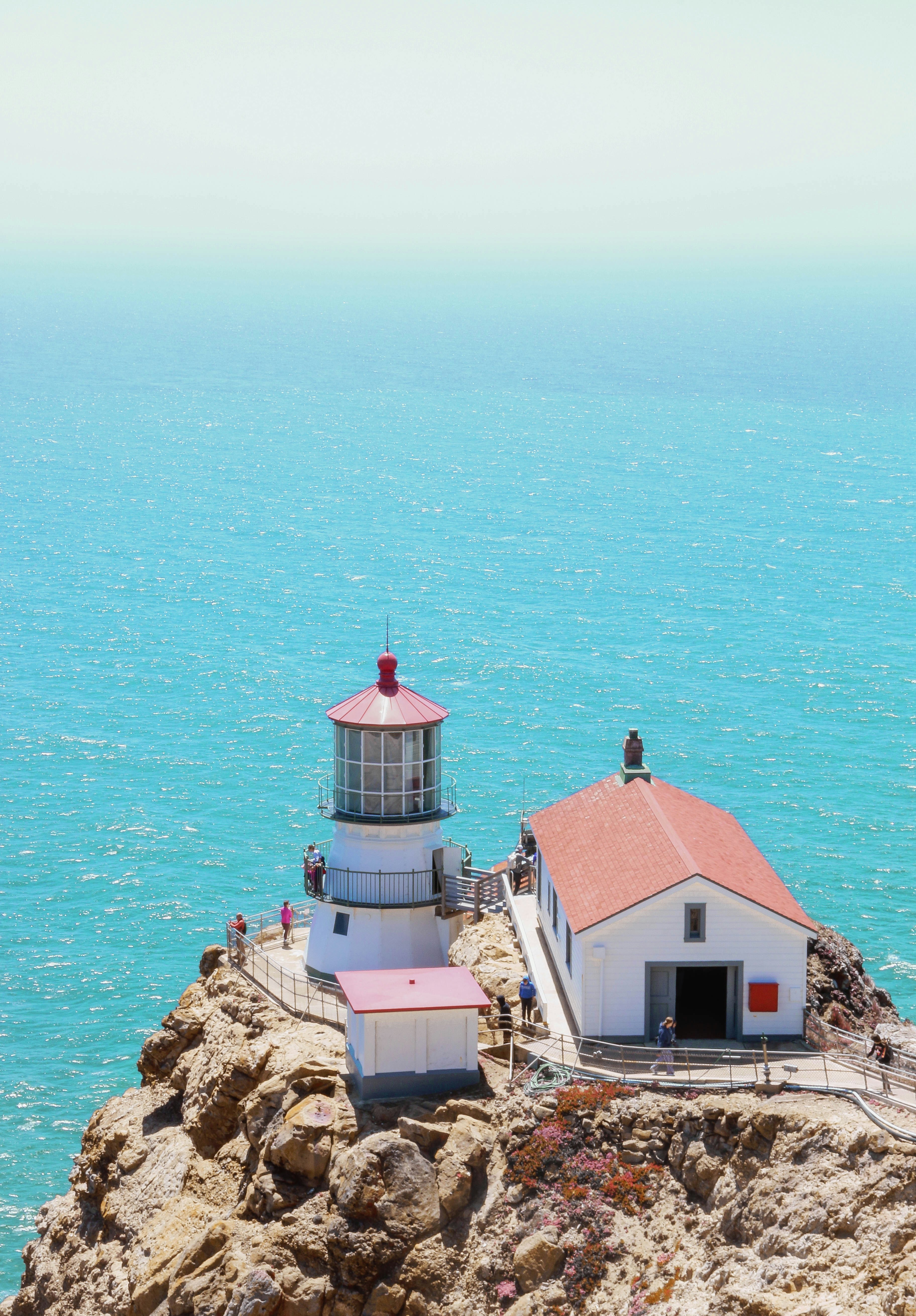 A lighthouse on a rocky shore photo – Free Point reyes lighthouse Image ...