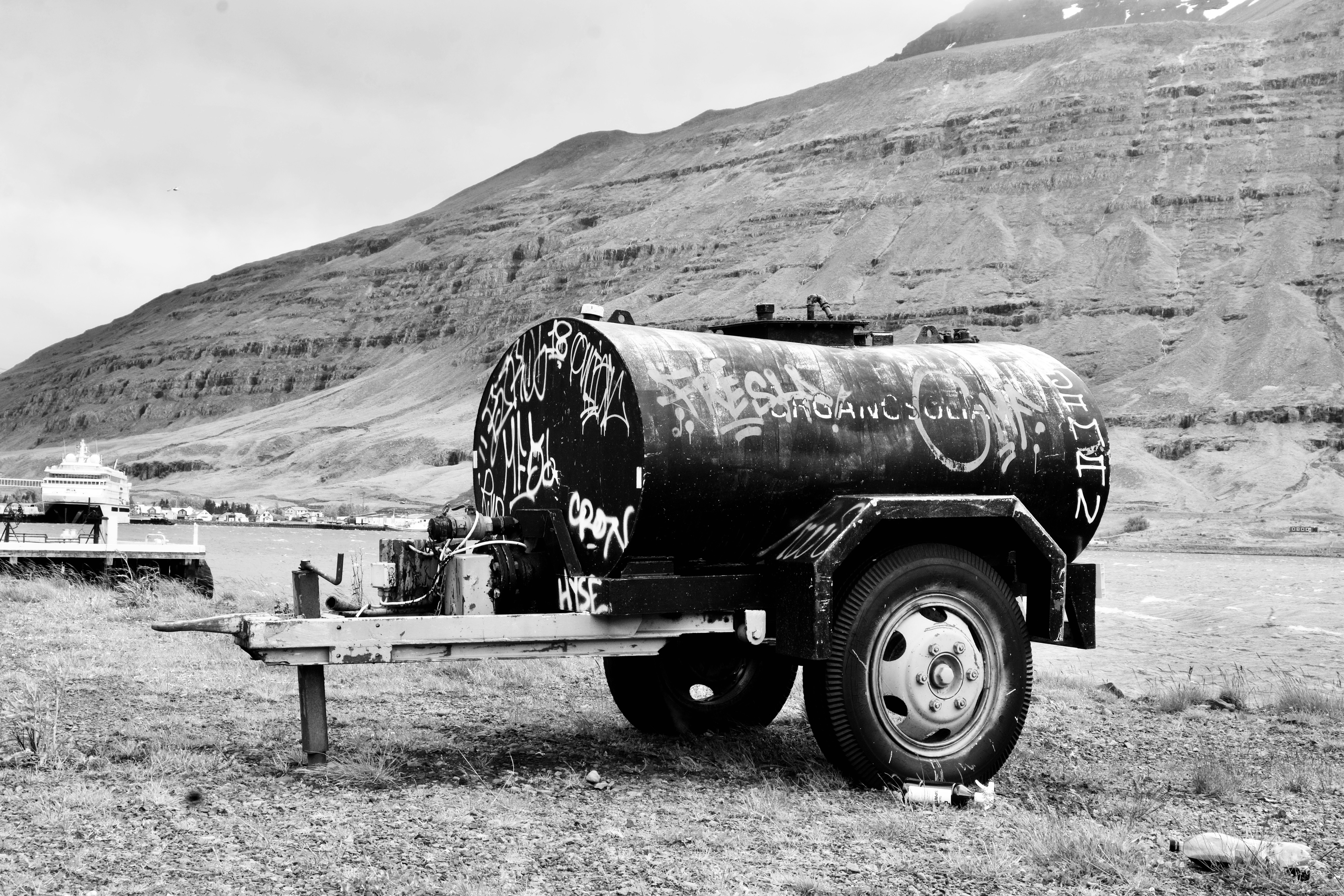 Graffiti-Tinted Tank Trailer Against a Rugged Mesa