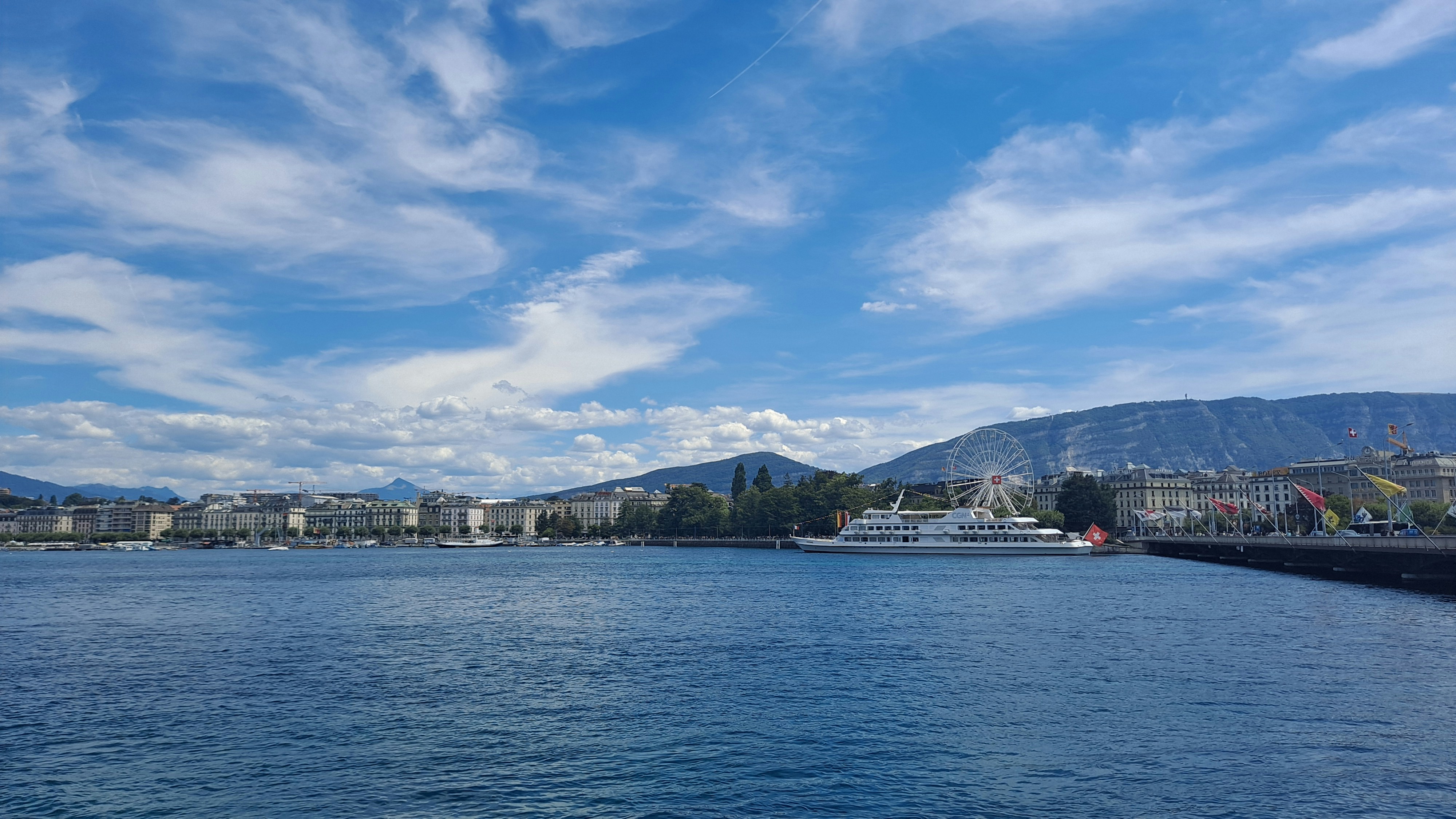 a body of water with a boat in it and a city in the background