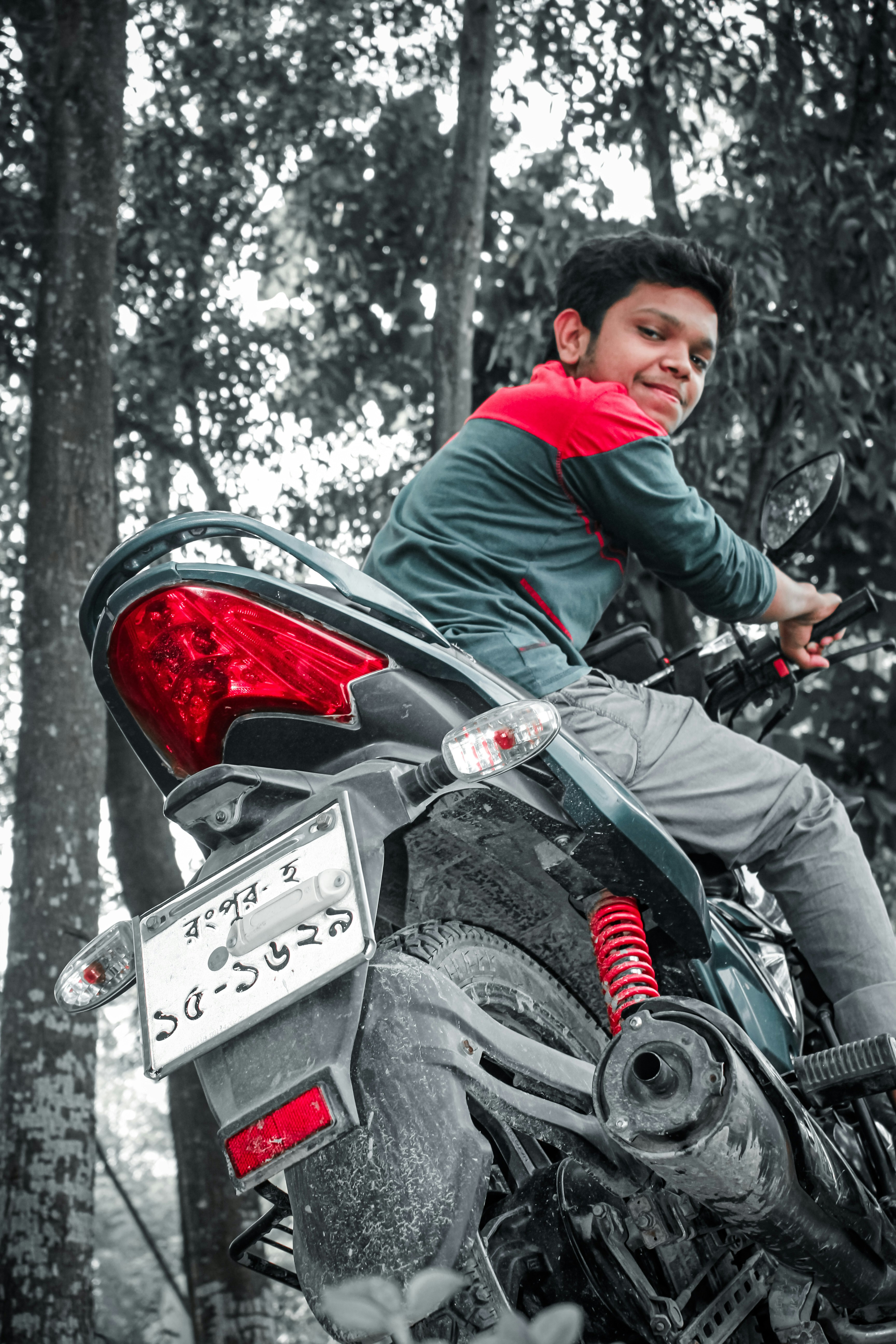Red-Accented Rider on a Tilted Motorcycle in the Forest