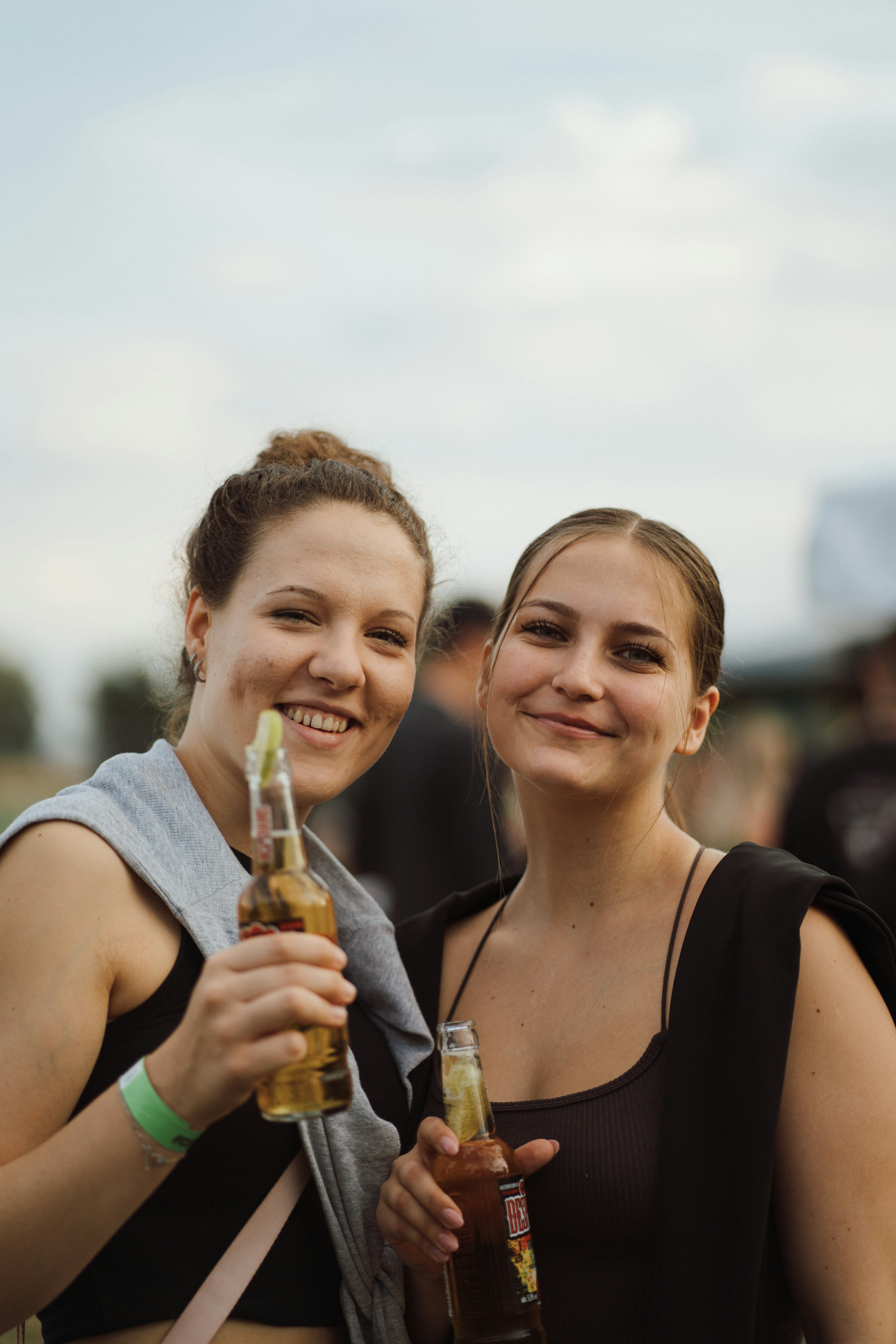 A couple of women holding beer bottles photo – Free Beer Image on Unsplash