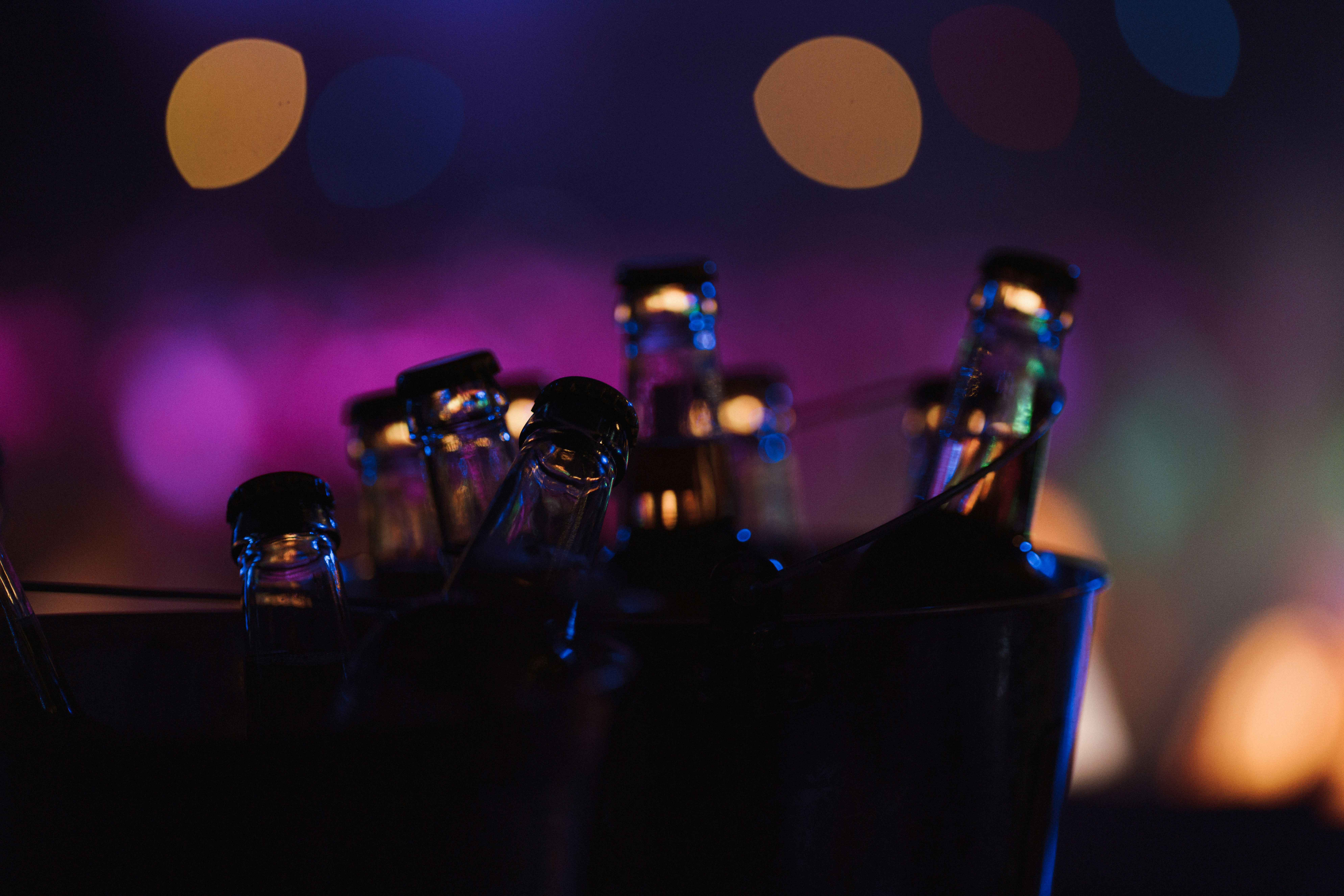 Neon Bokeh Halo Around a Quiet Bottle Cluster