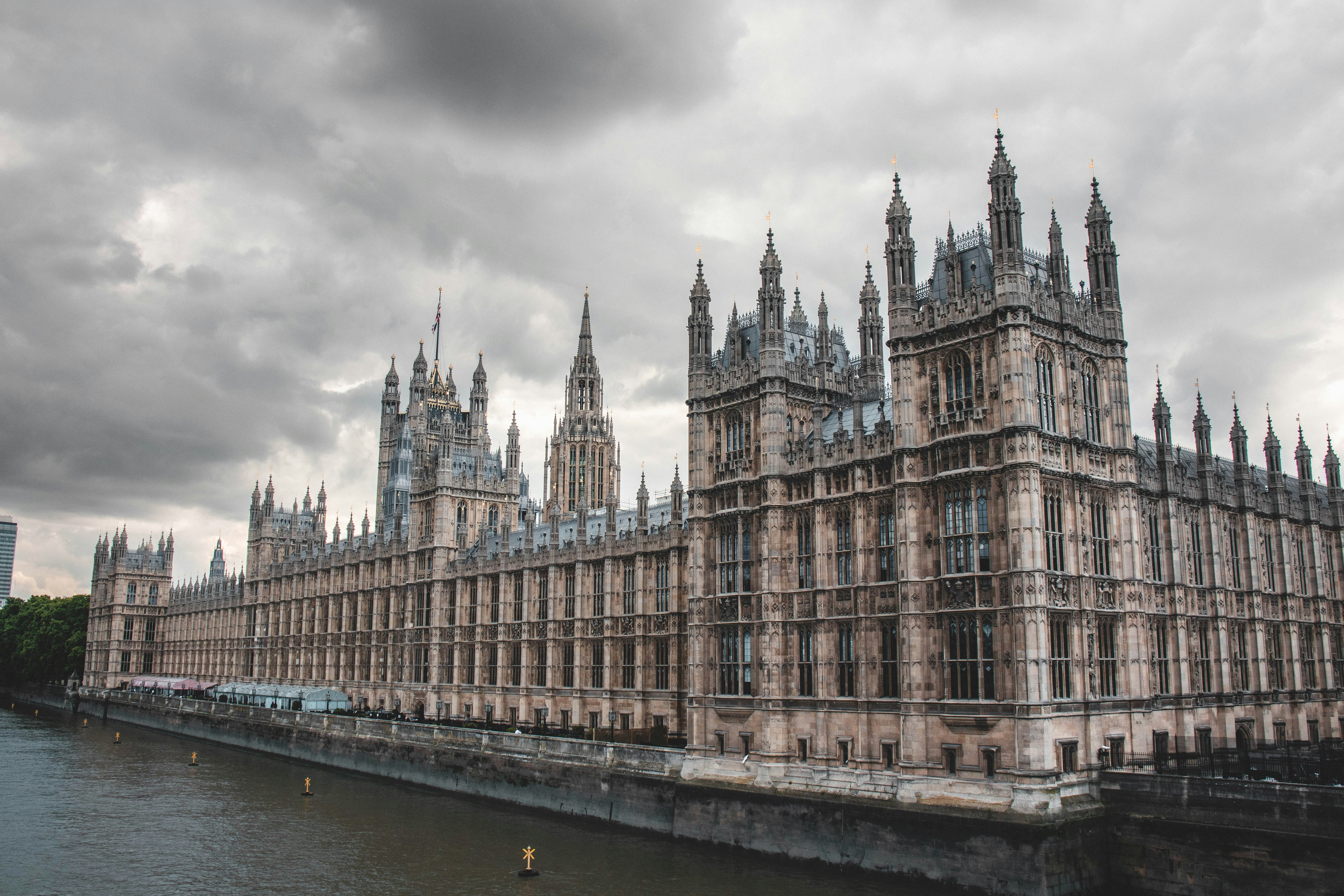 A large building with towers with Palace of Westminster in the ...