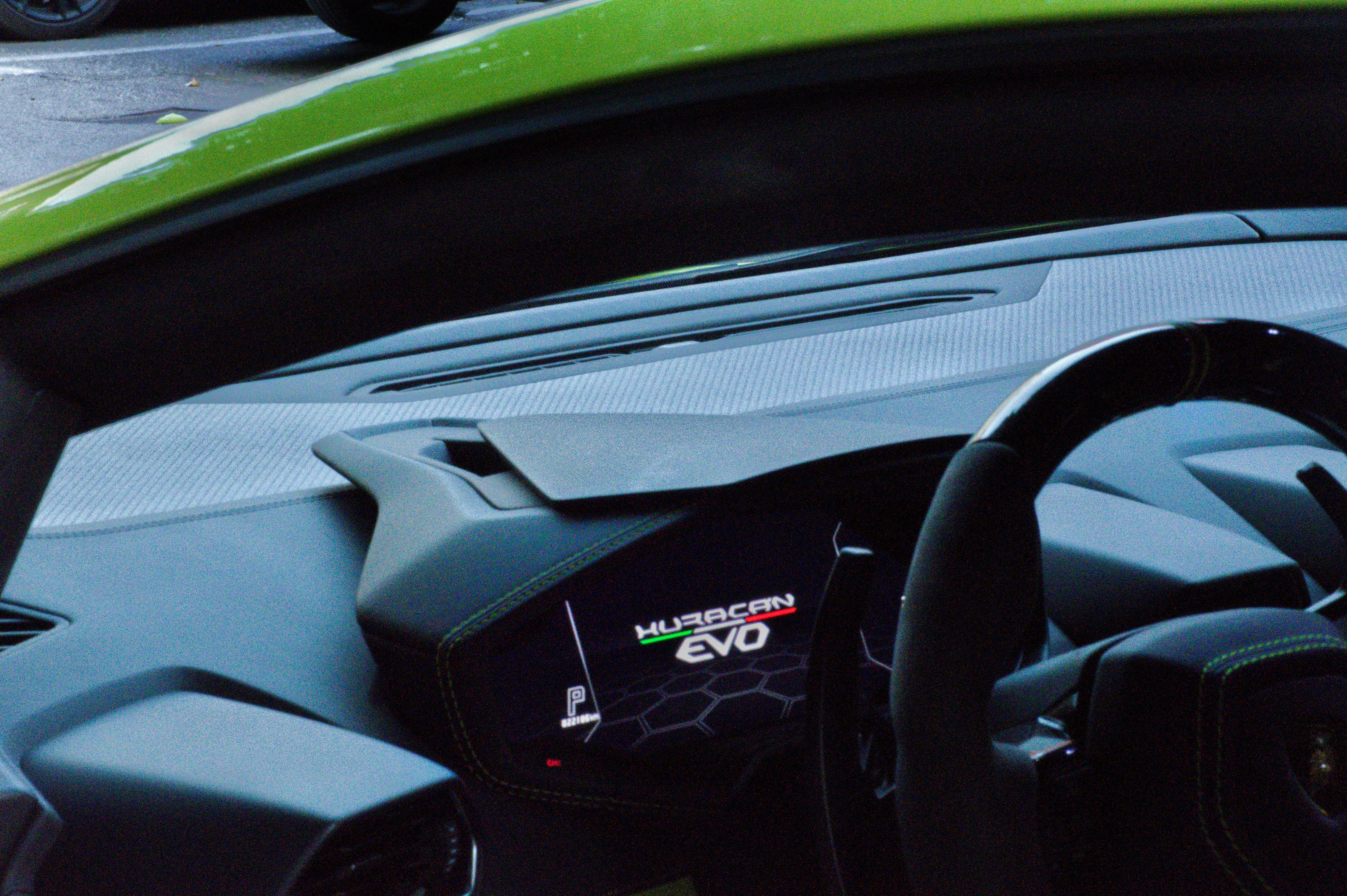 Neon-green framing of a Lamborghini Huracan Evo cockpit