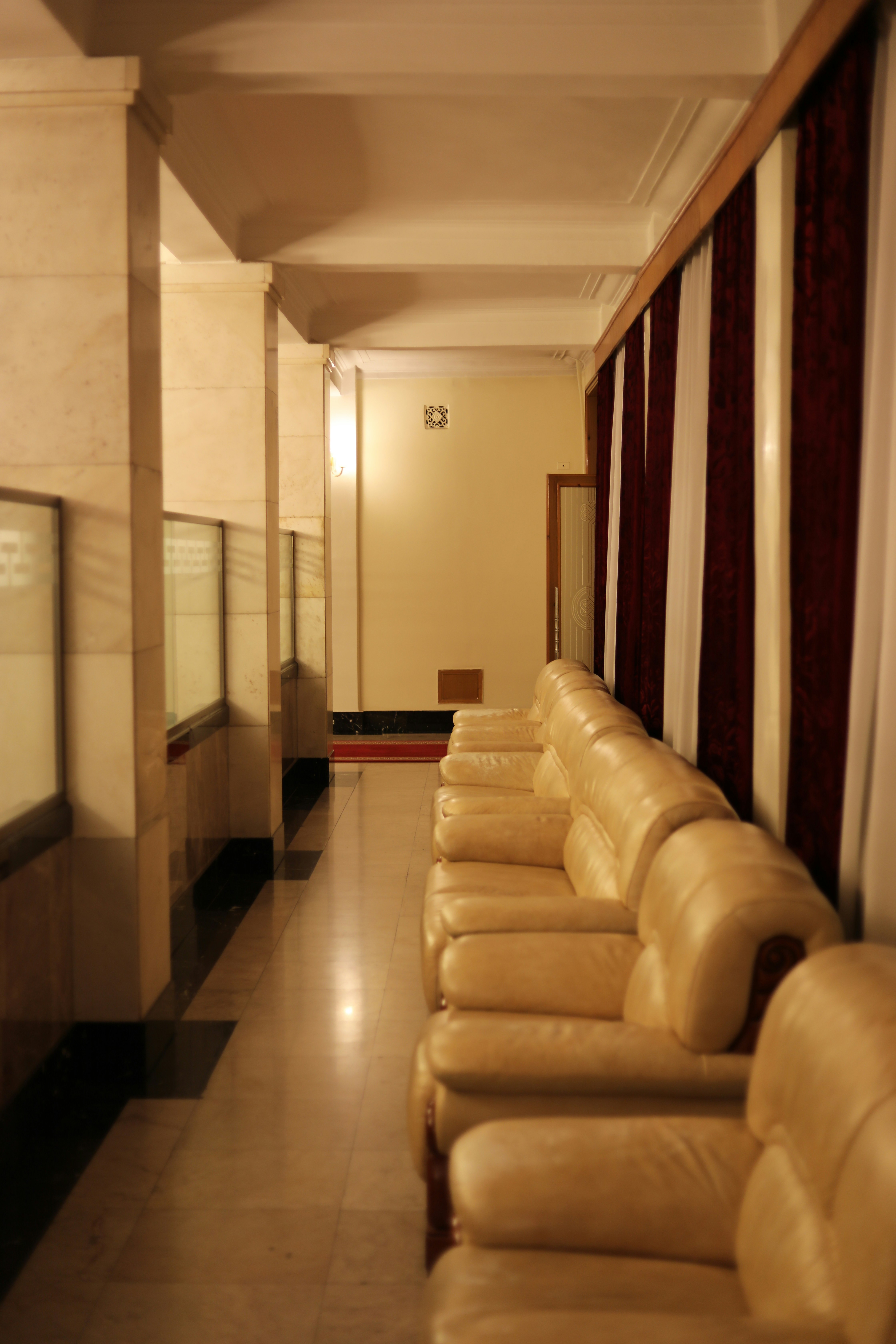 A long hallway with a couch photo – Free Government palace Image on ...
