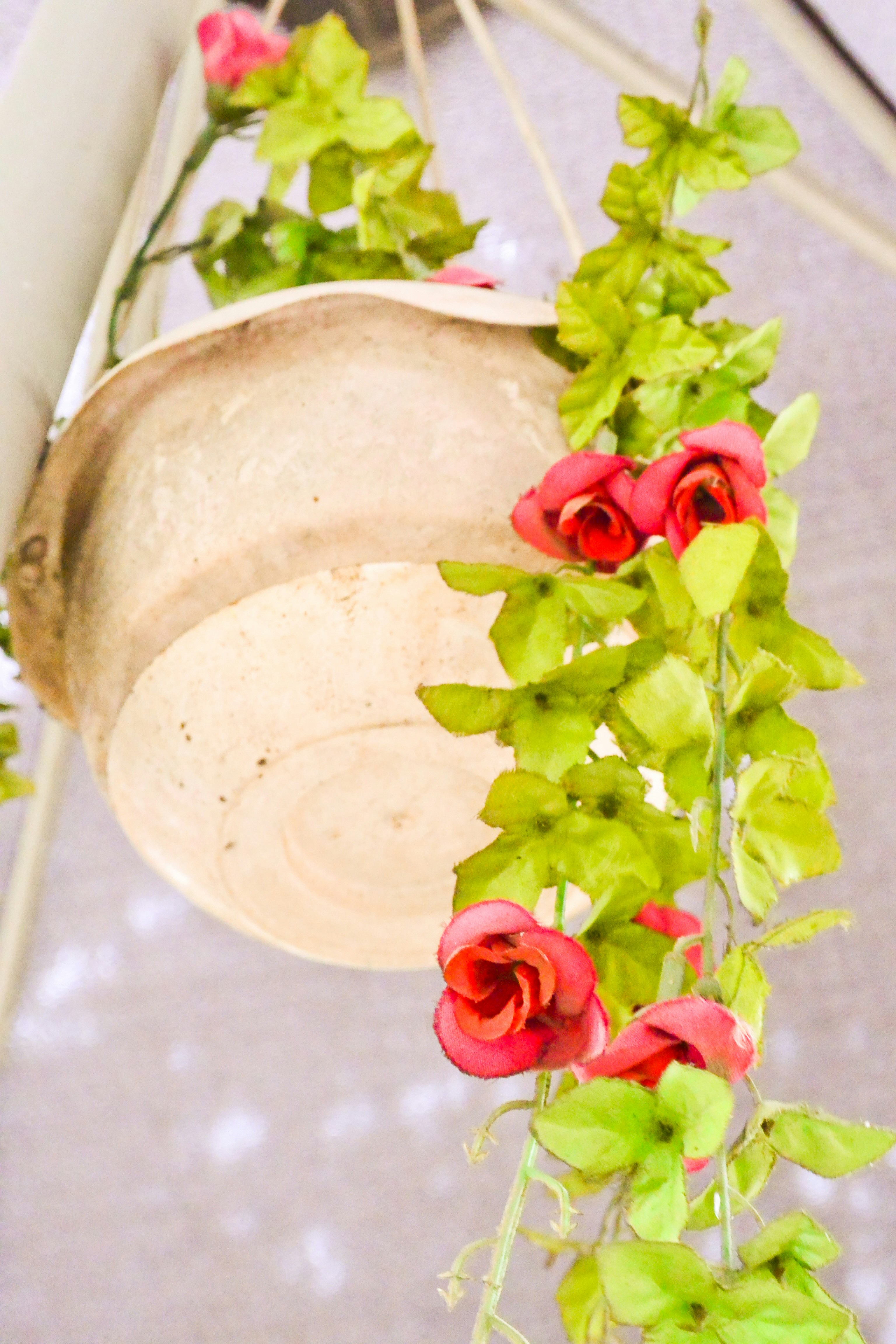 Flower garland draped over a rustic hanging pot