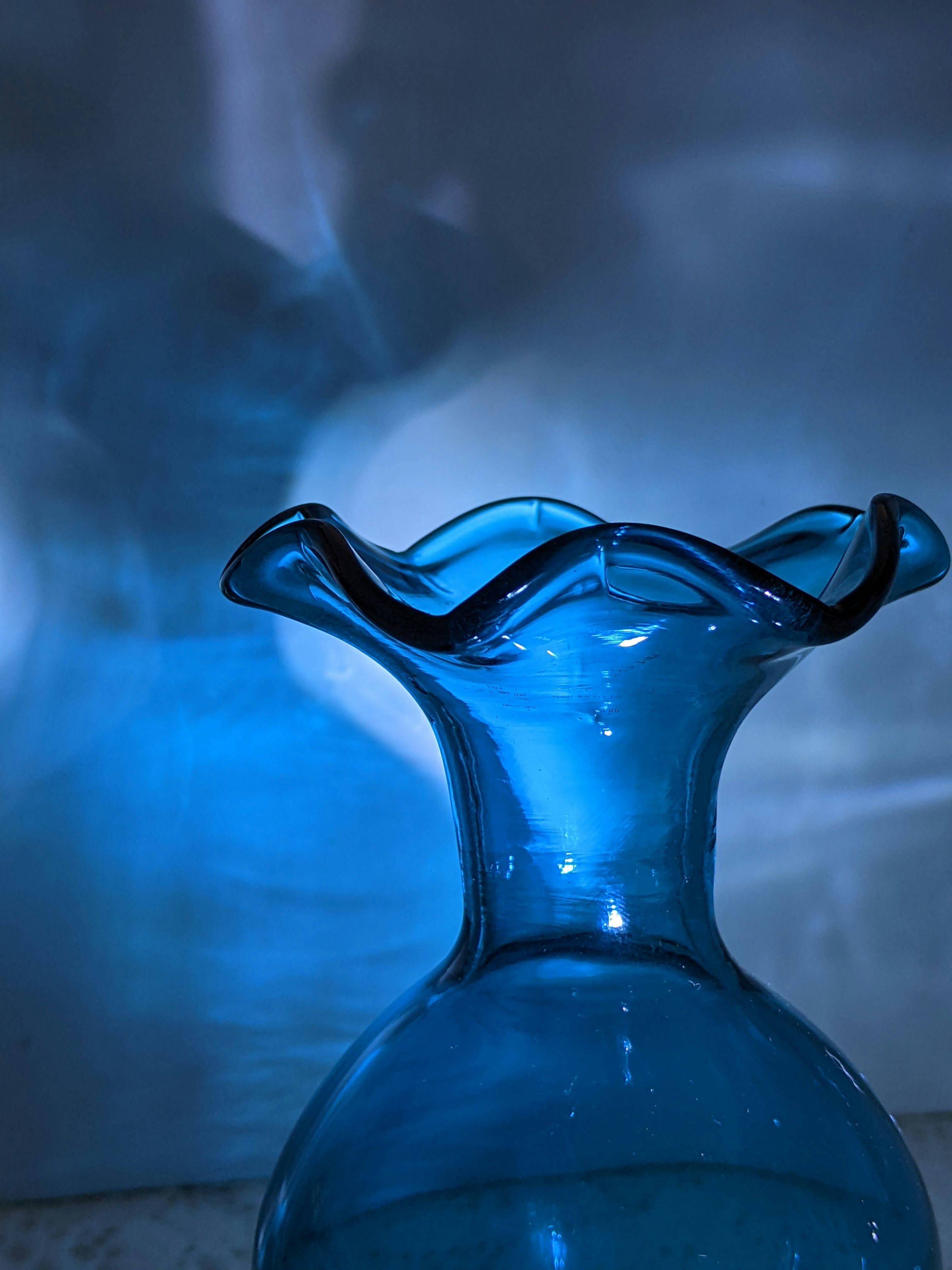 Blue Glass Vessel in Quiet Glow: A Close-Up Study of Form and Light
