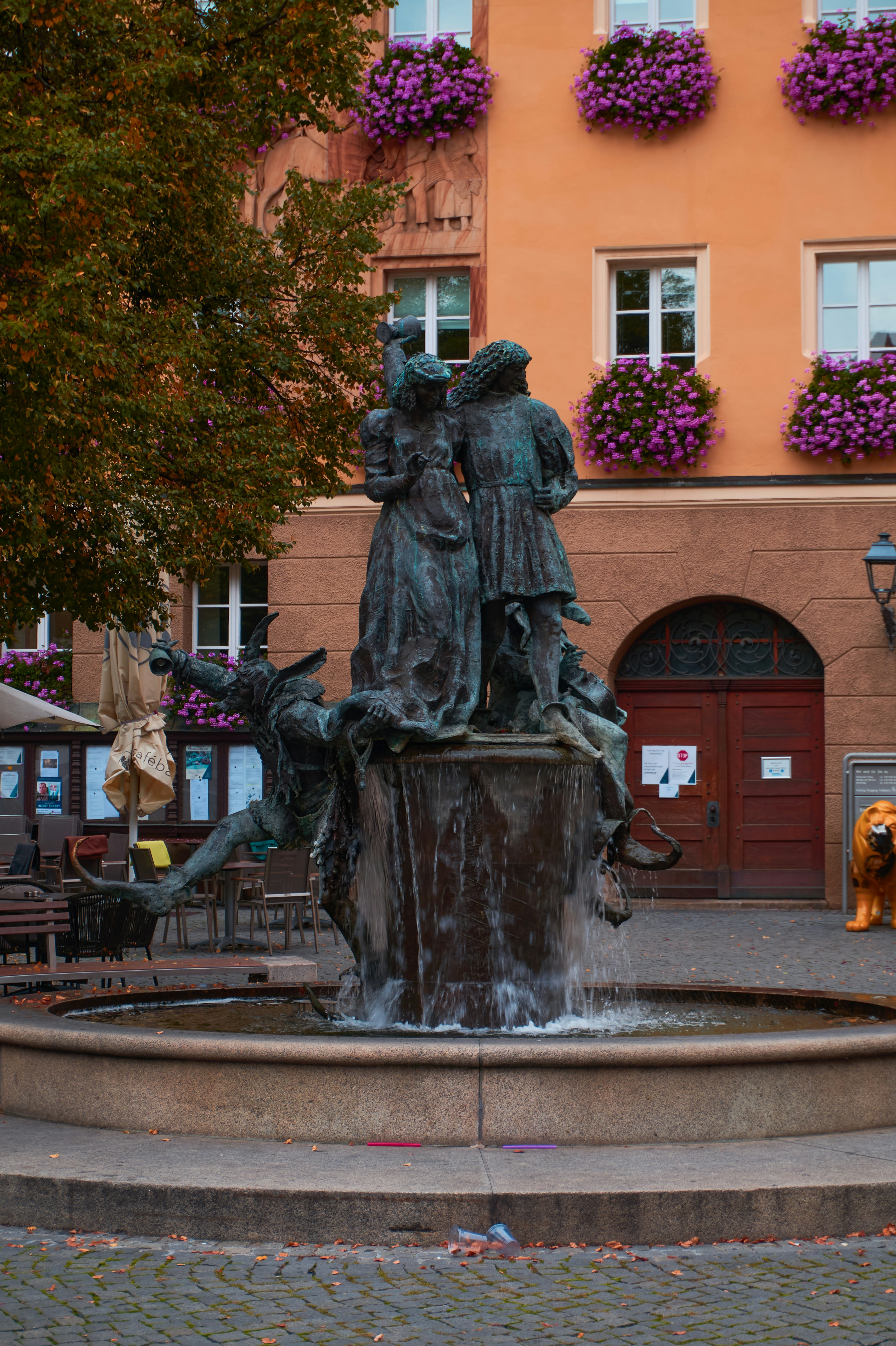 a statue of a man and a woman in a fountain