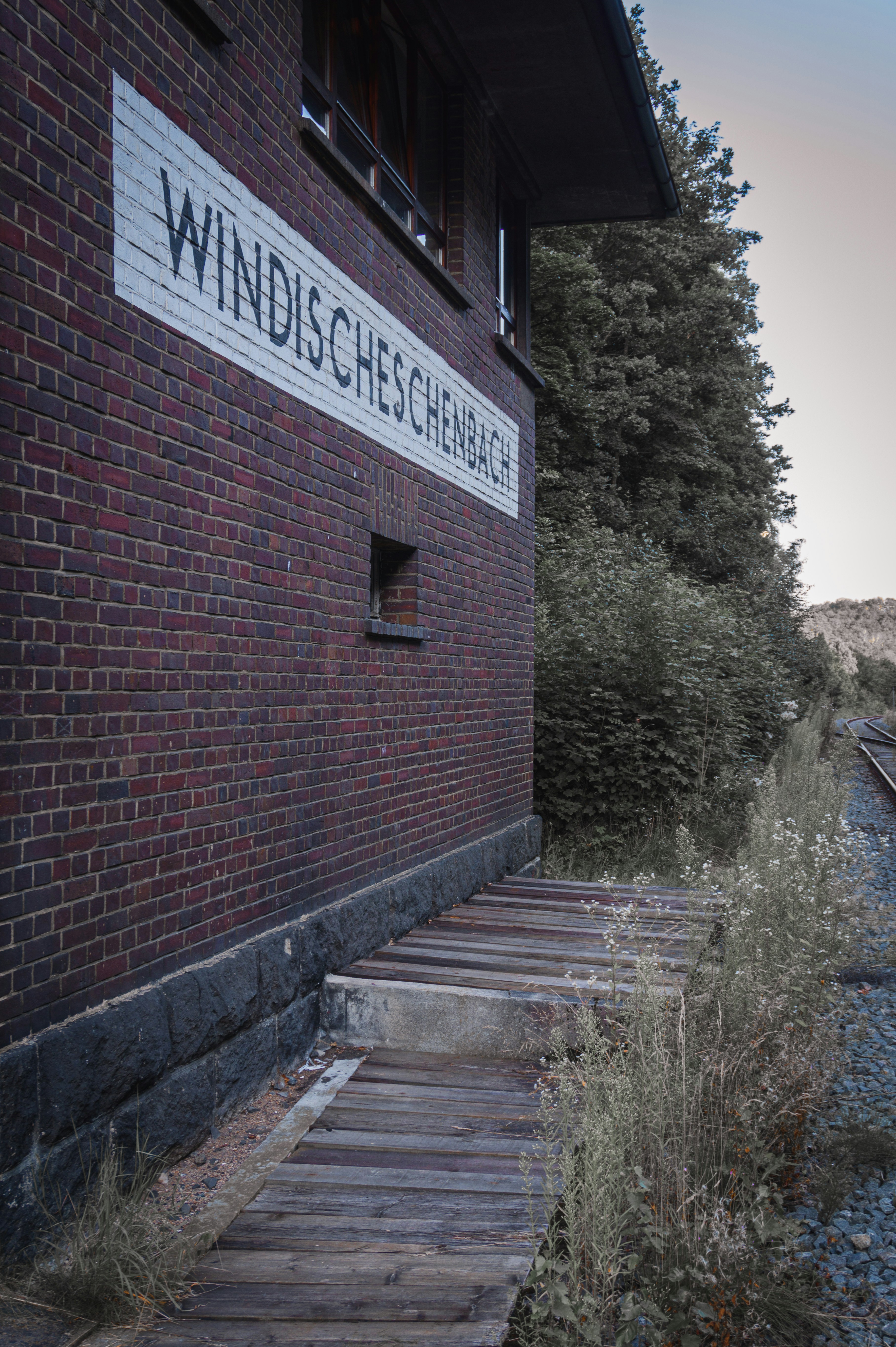 Weathered Brick Wall by the Rails: a Quiet, Overgrown Corner