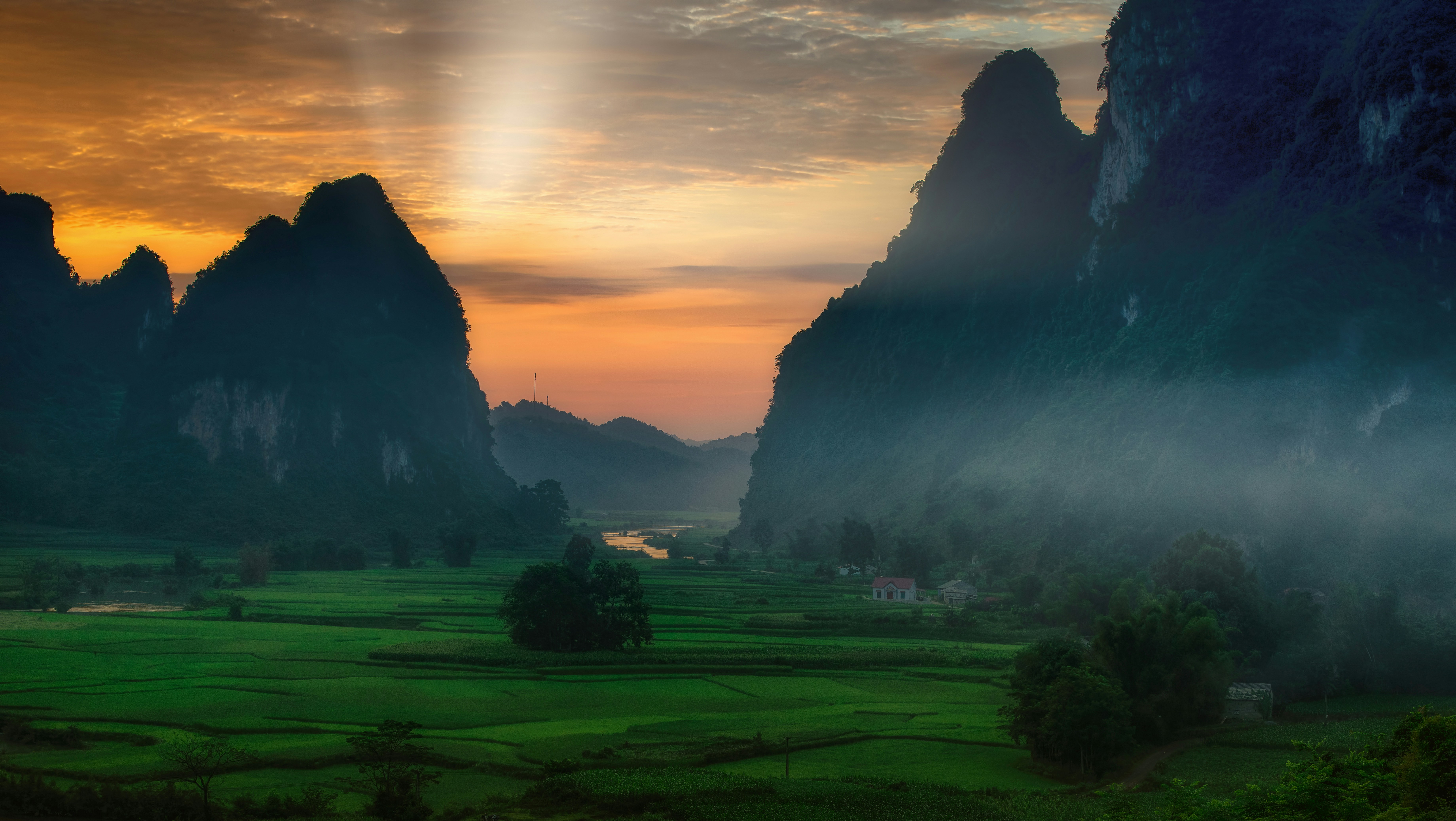 Sunlit Gateways: Distant Peaks Embrace the Quiet Valley