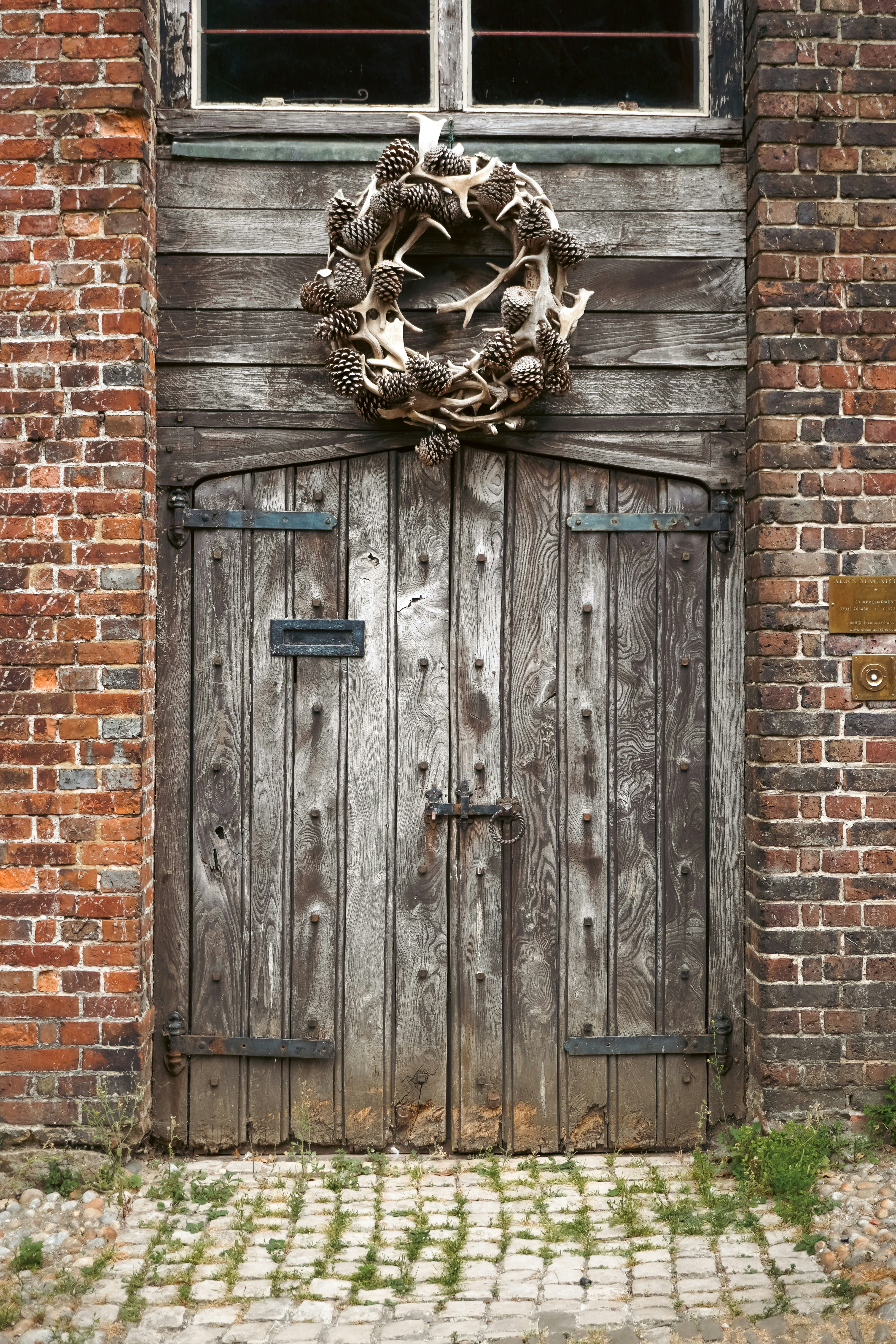 Wreath of Antlers Framing a Weathered Door