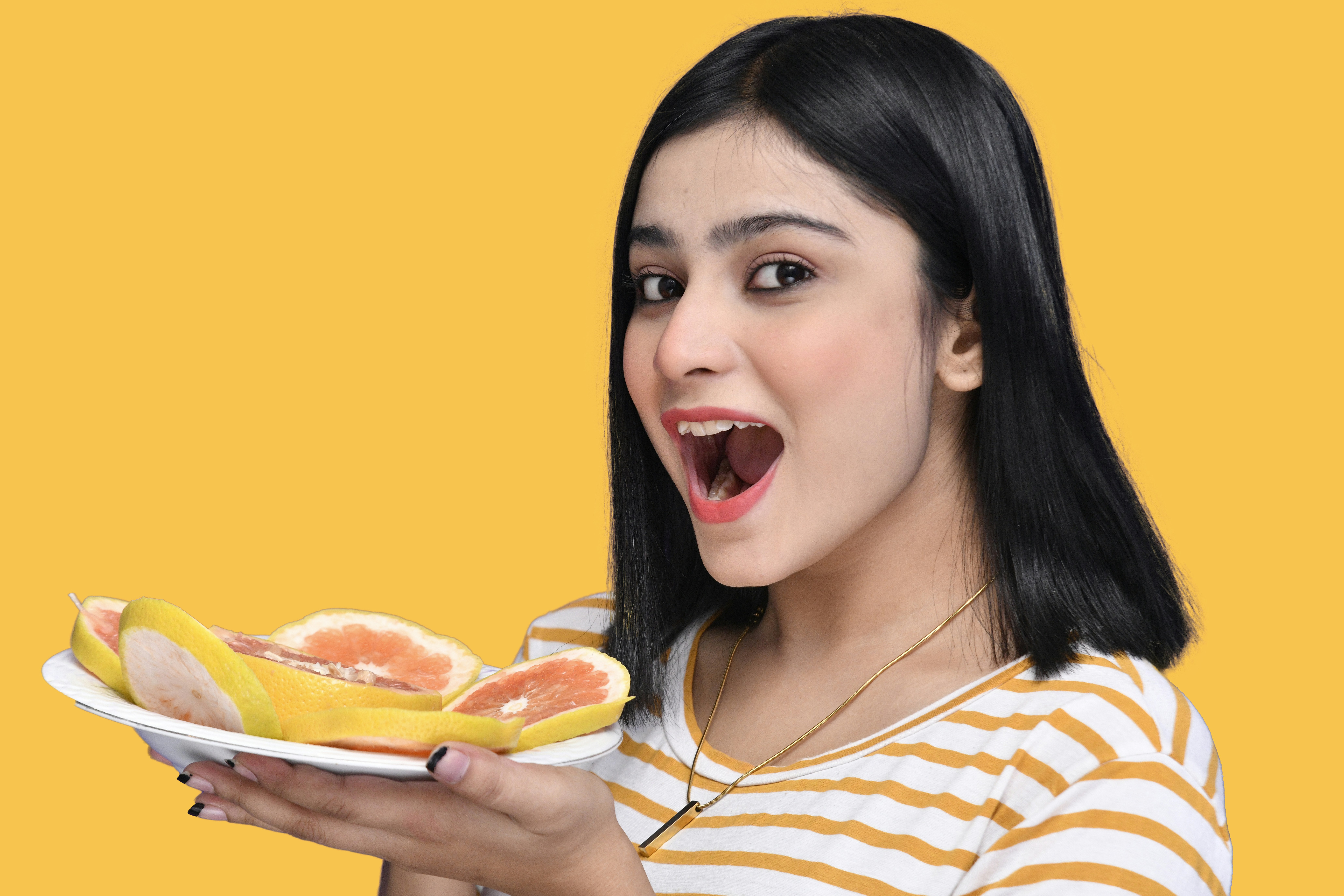 Citrus Glow Portrait: A Bright Smile on a Yellow Backdrop