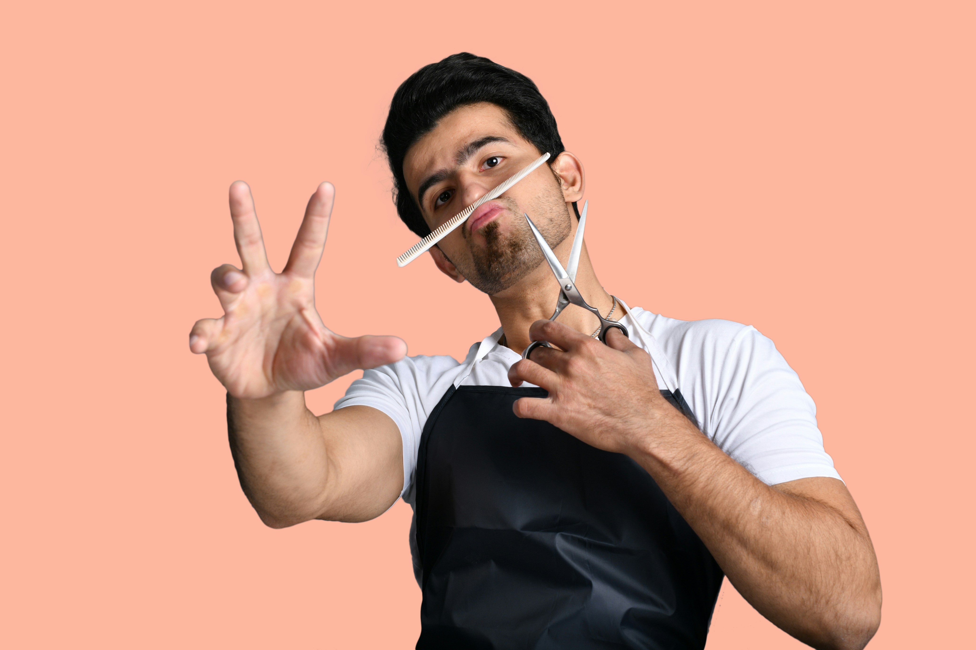 Cutting-Edge Mischief: A Chef's Playful Hazard Against a Peach Backdrop