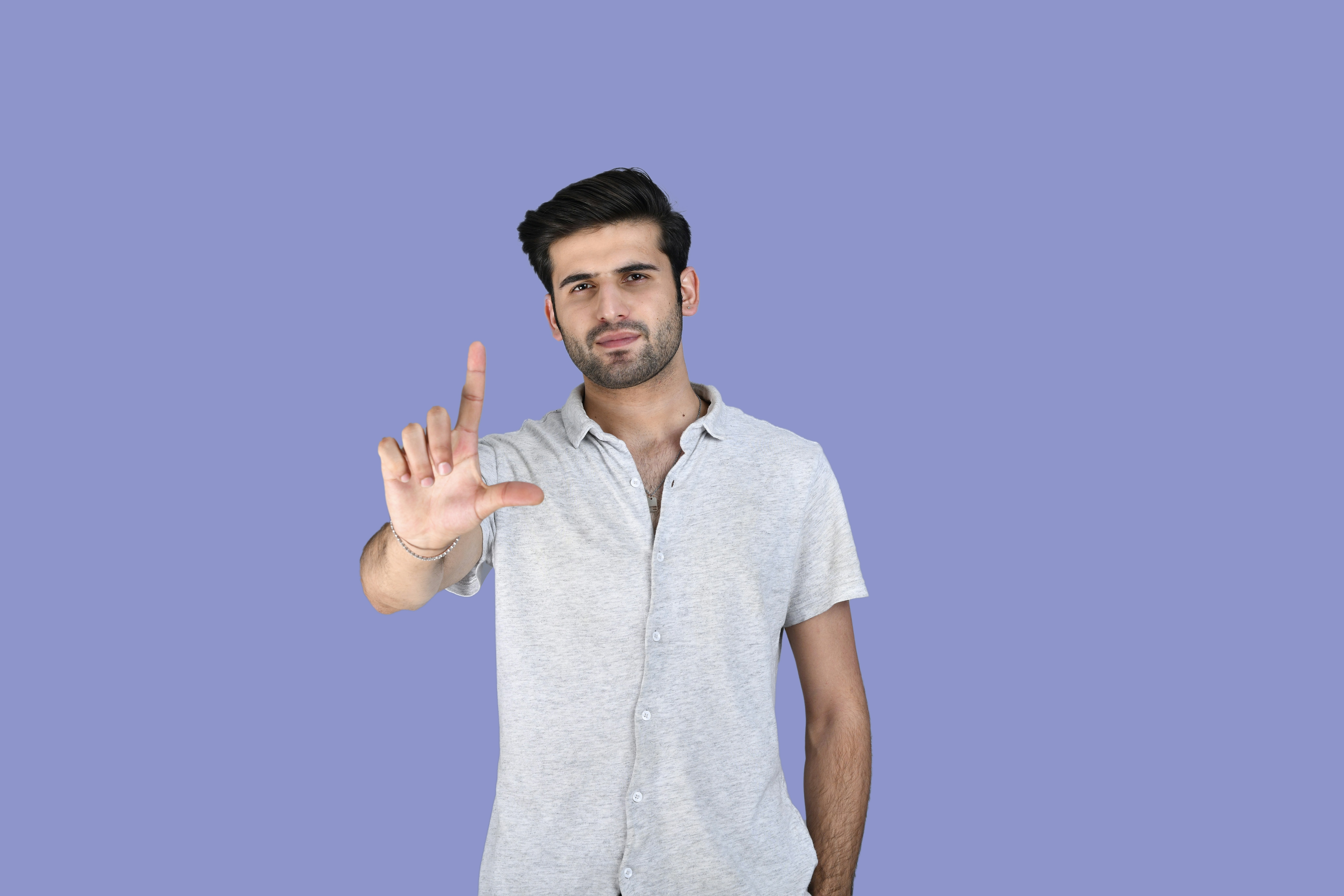A man holding up his middle finger photo – Free Purple Image on Unsplash