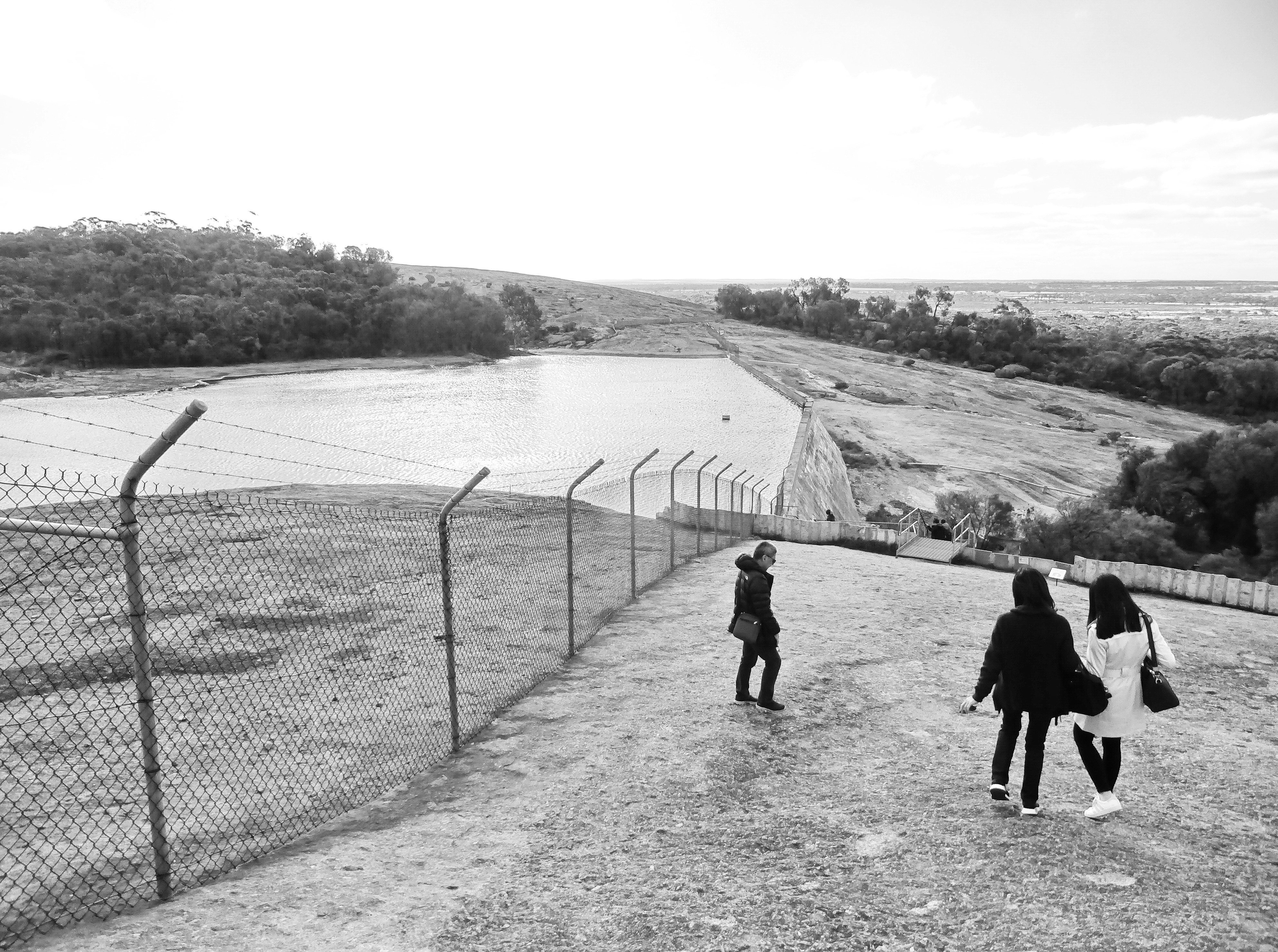 People walking on a path near a river photo – Free Grey Image on Unsplash