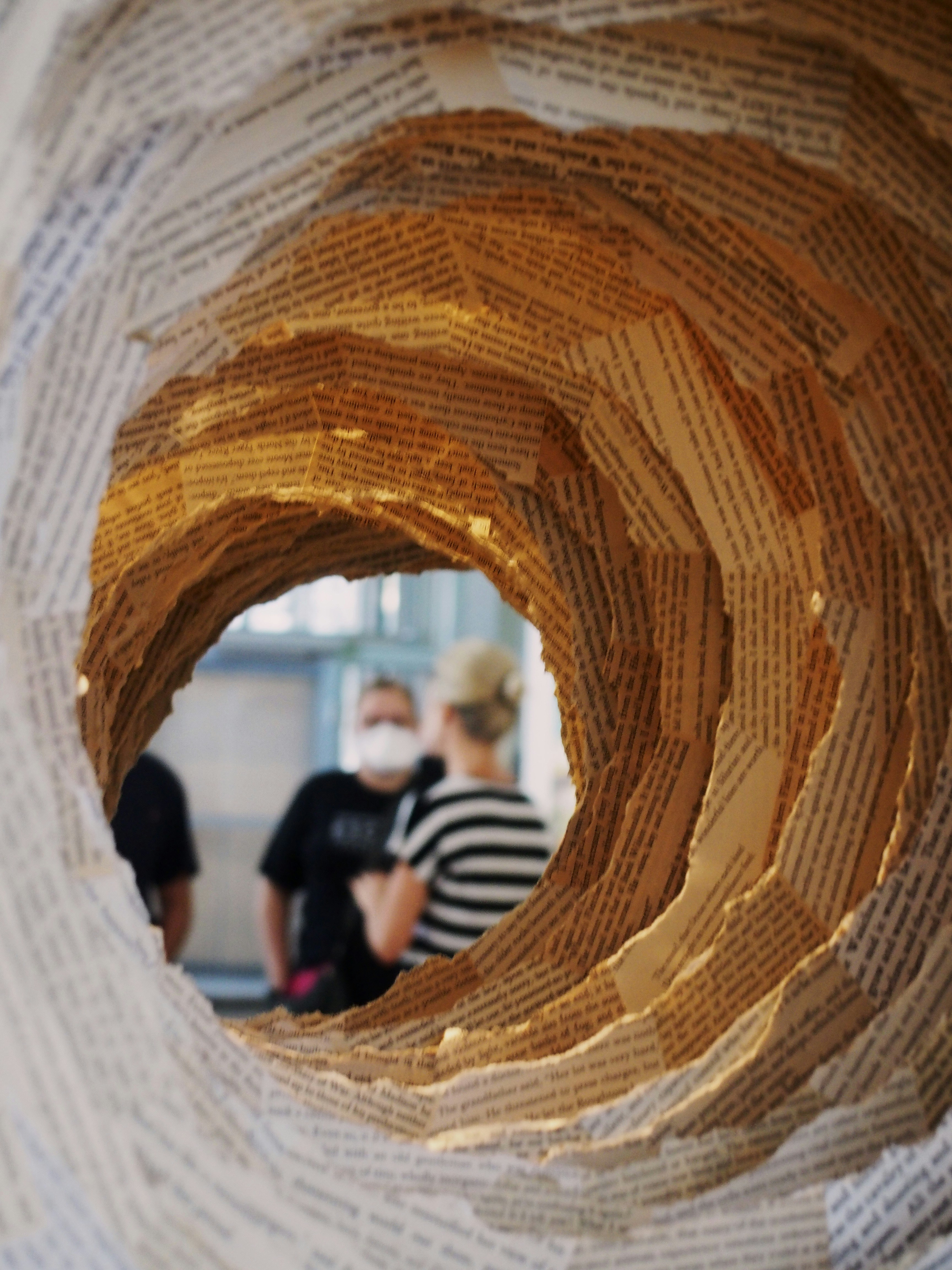 Through the Paper Spiral: Faces in the Quiet Unraveling