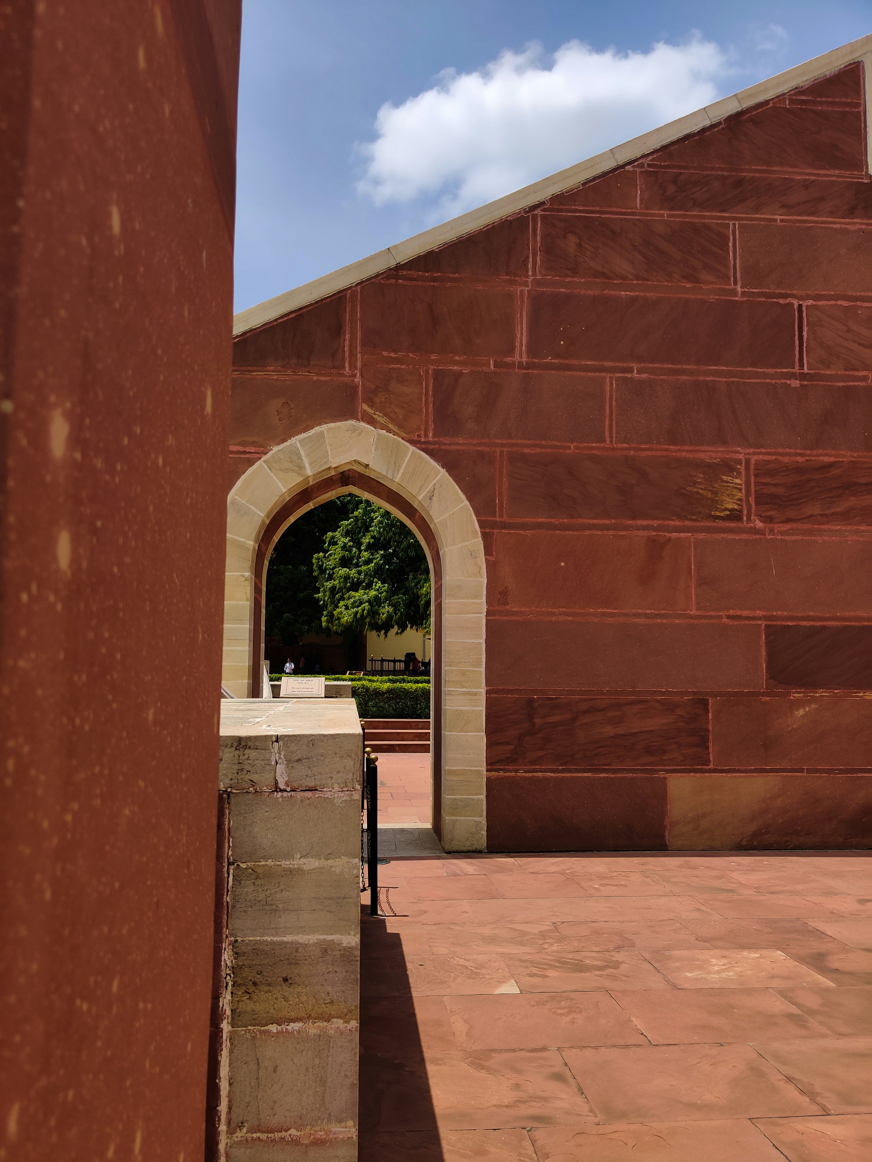 a brick archway with a tree in the middle